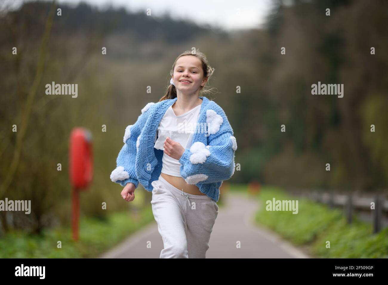 Girl running on a path Stock Photo - Alamy