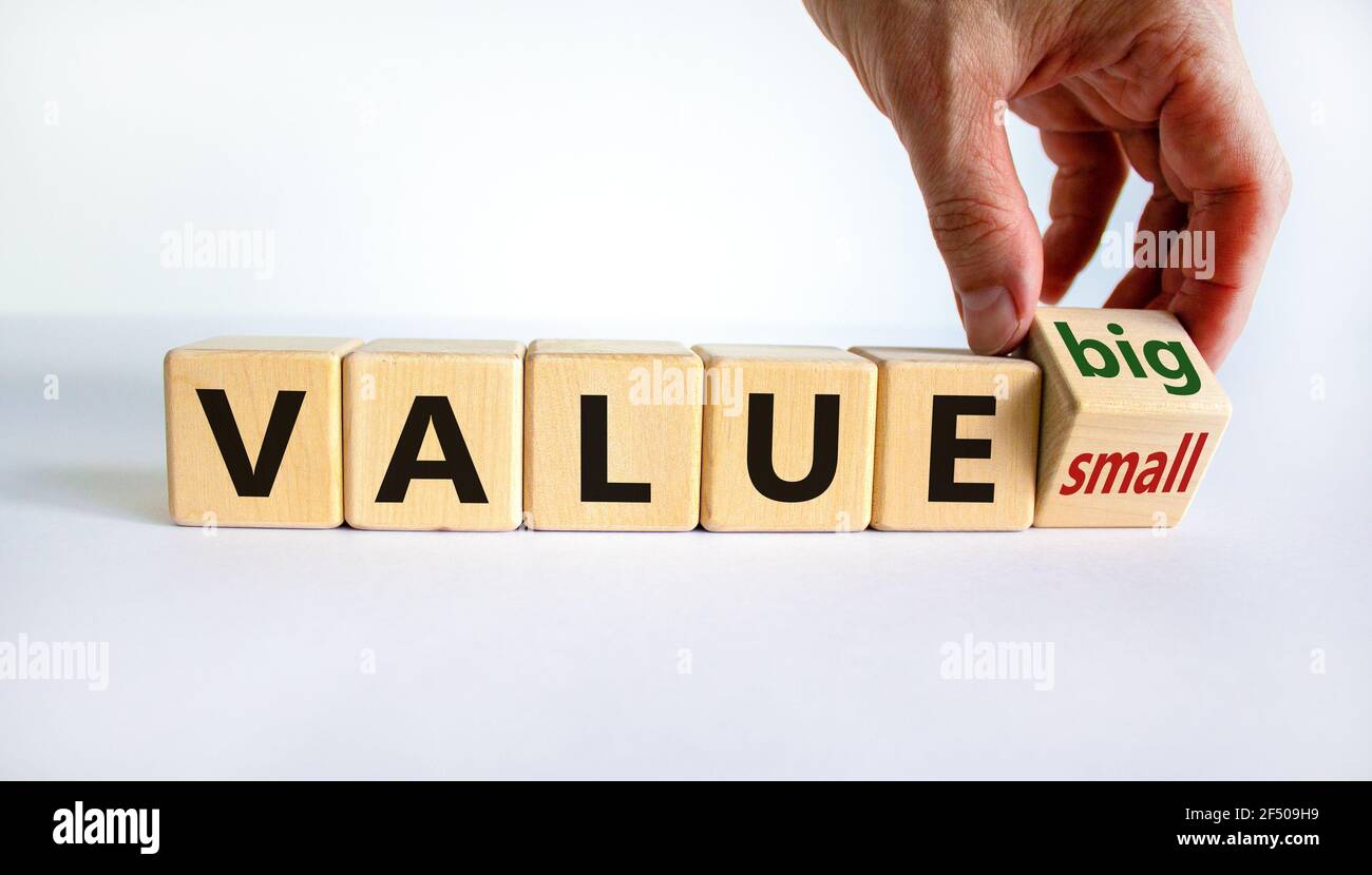 Small or big value symbol. Businessman turns wooden cubes and changes ...