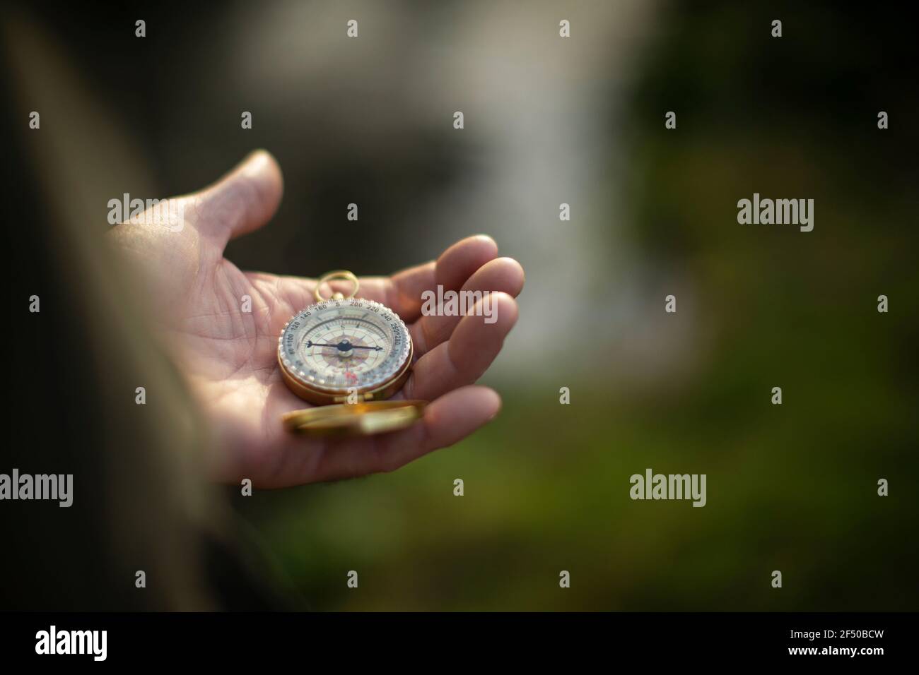Close up man holding compass Stock Photo - Alamy