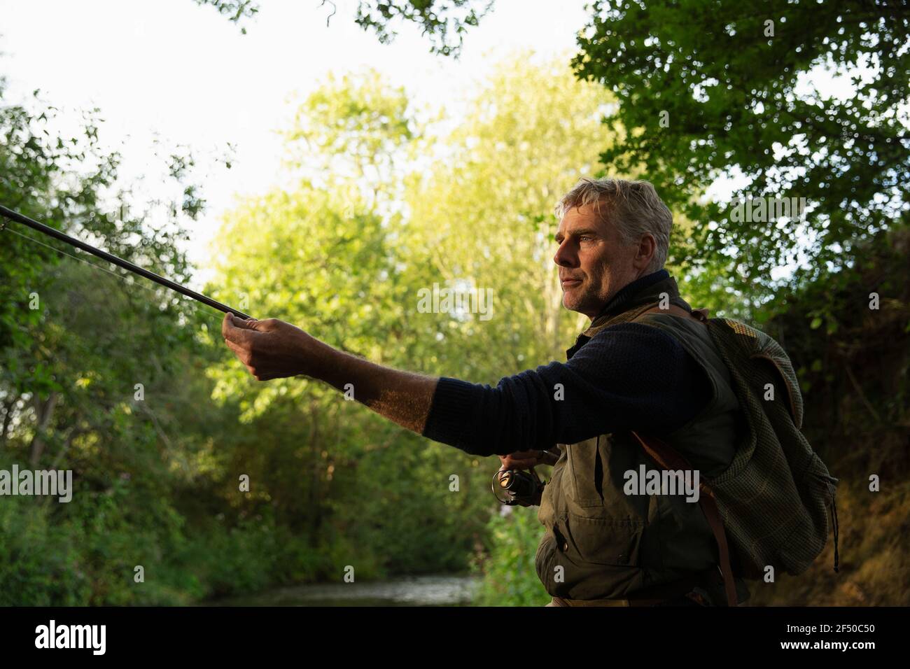 Man fly fishing pole hi-res stock photography and images - Alamy