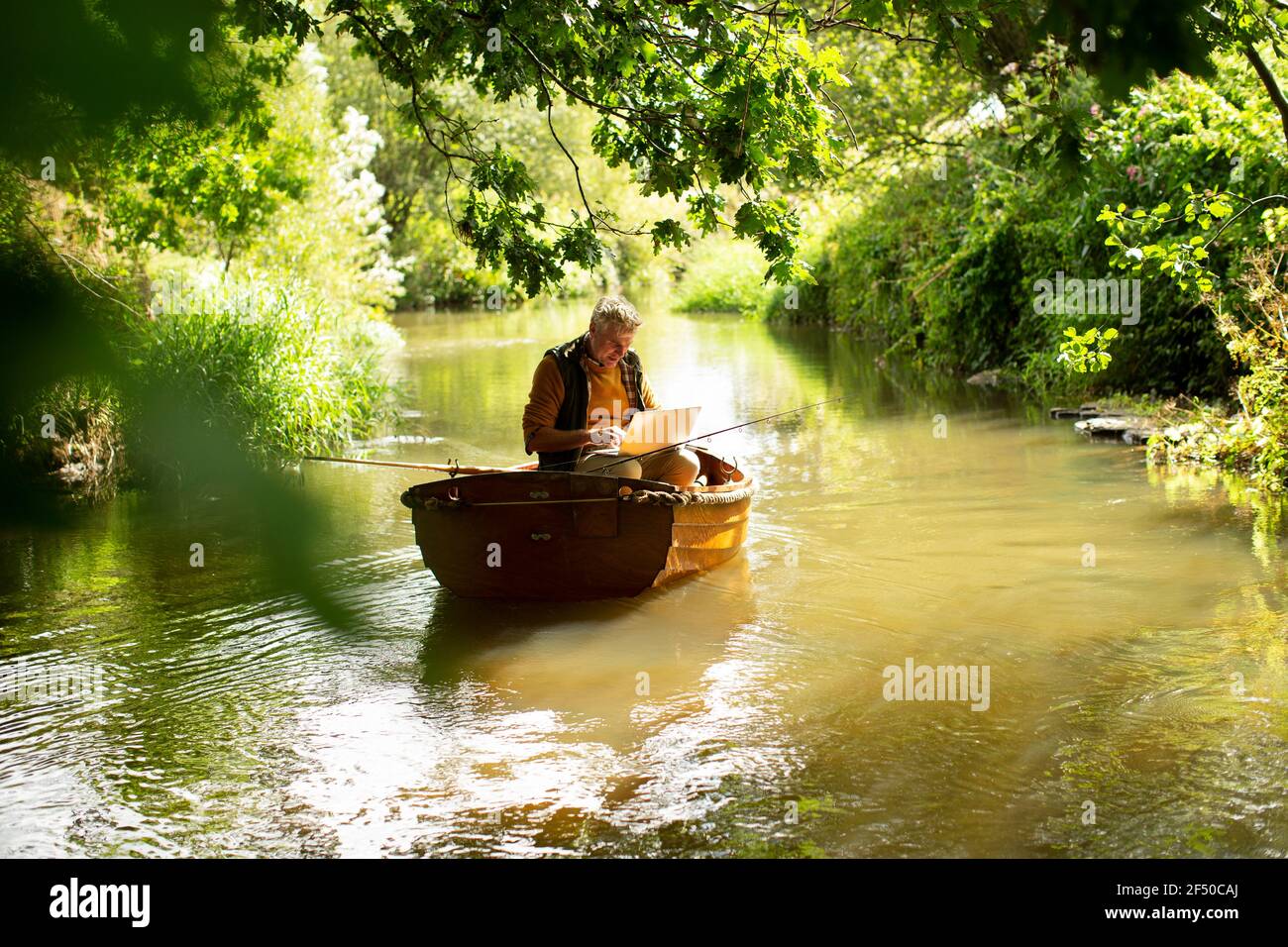 Man fishing using laptop on hi-res stock photography and images - Alamy
