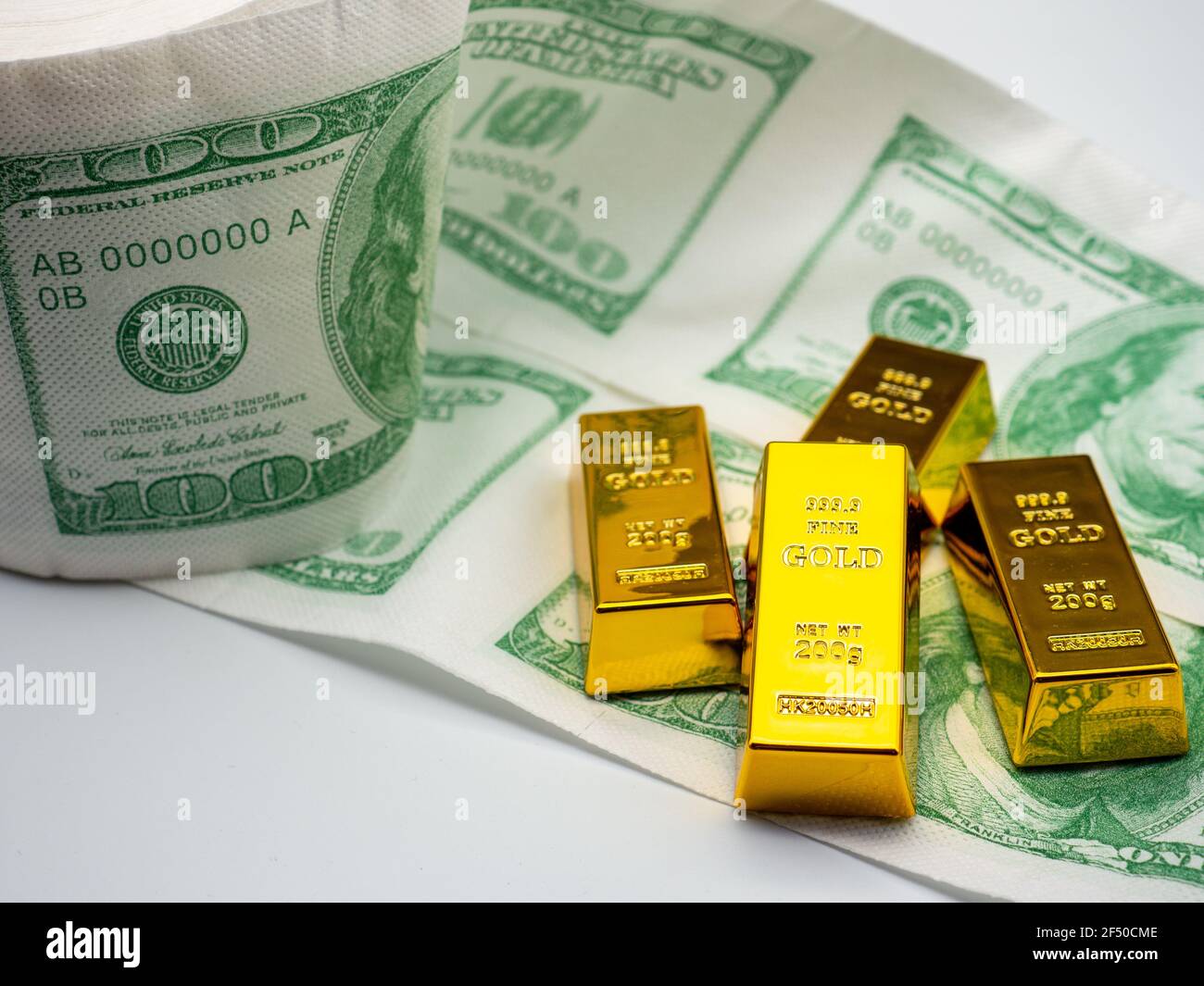 Closeup shot of dollar bill toilet paper and mini gold bars Stock Photo ...