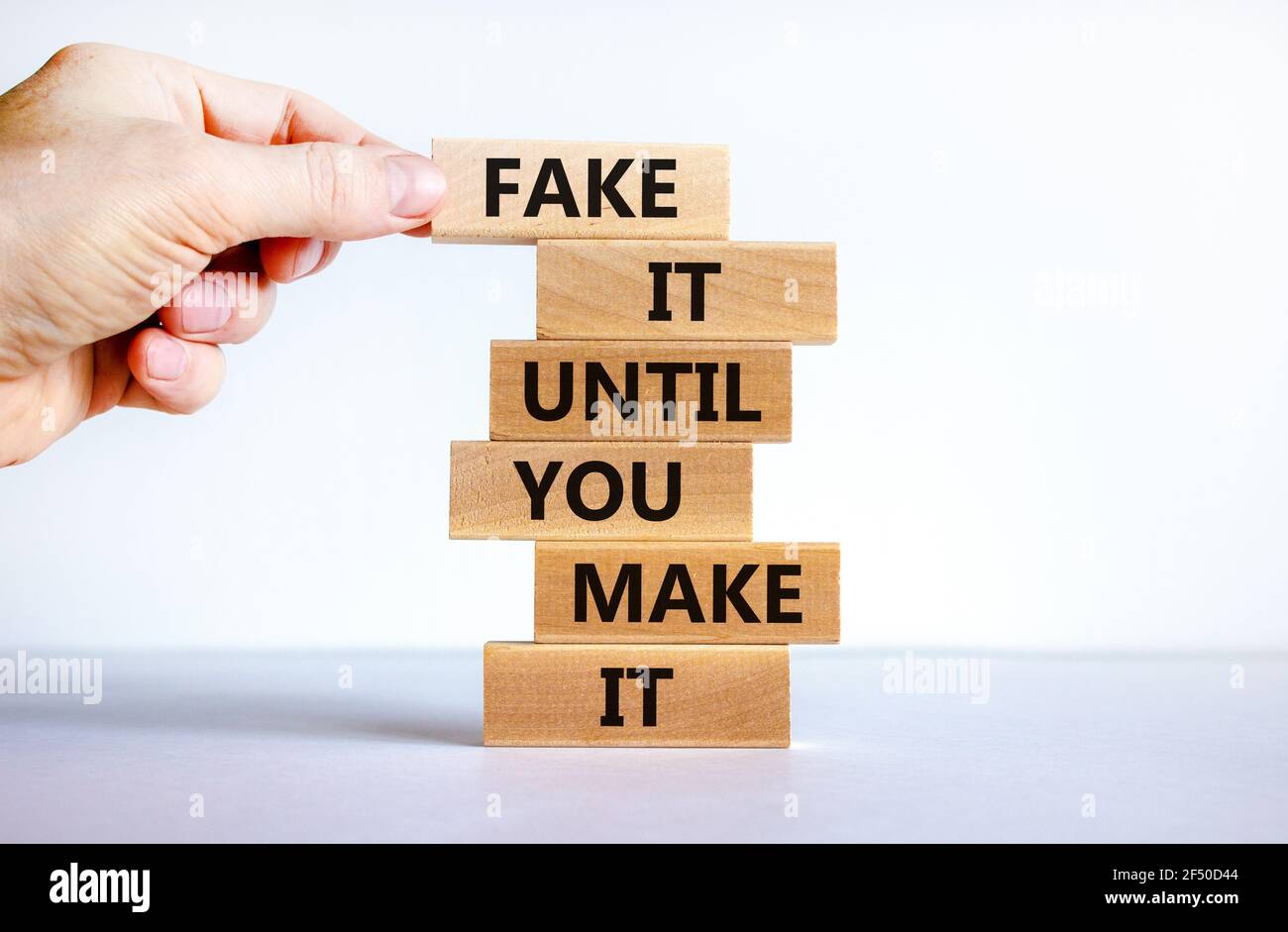 Fake it until you make it symbol. Wooden blocks with words 'Fake it ...
