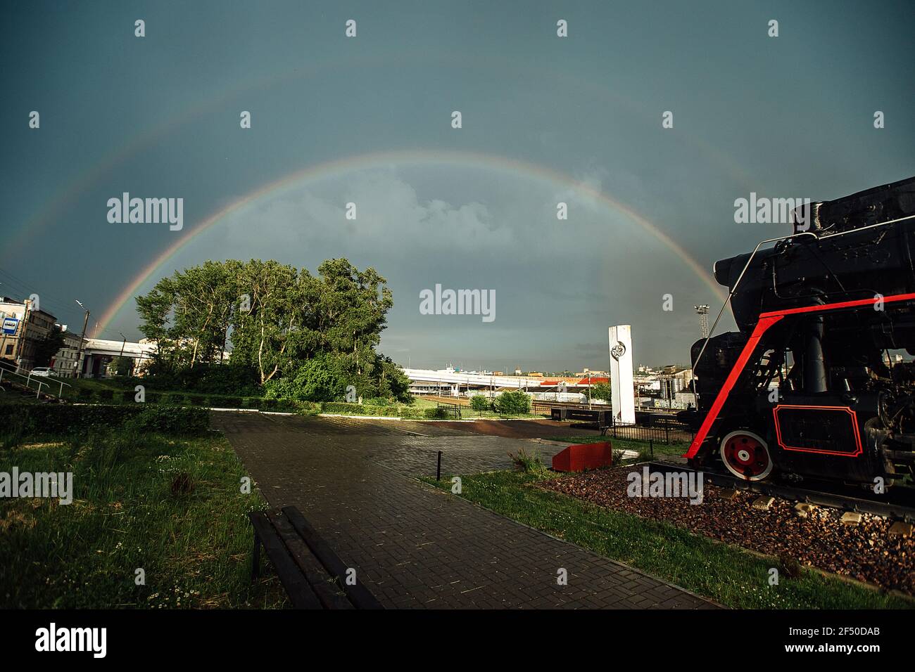 rainbow in the sky over the city after the rain. an old steam ...