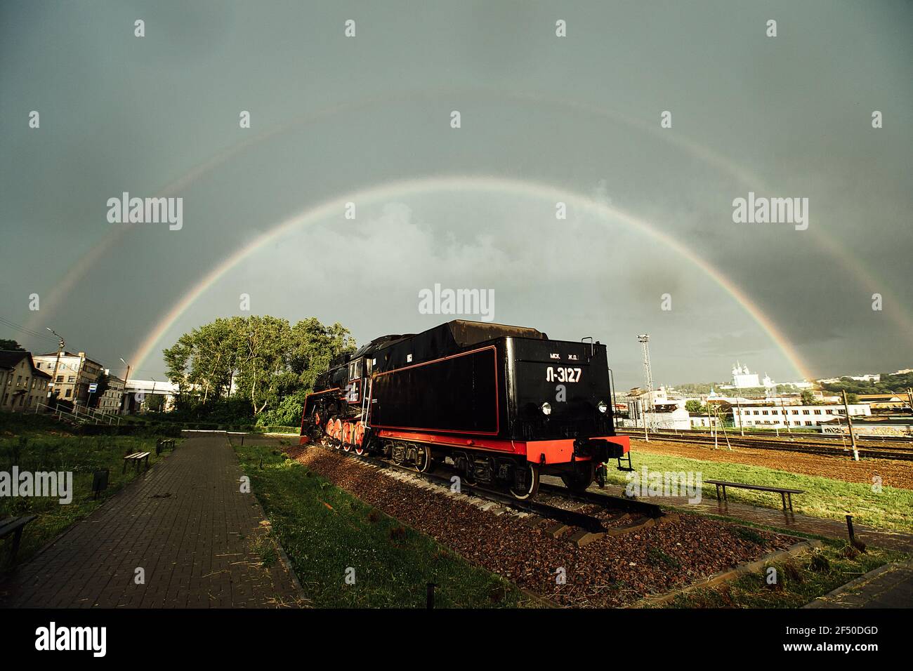 rainbow in the sky over the city after the rain. an old steam ...