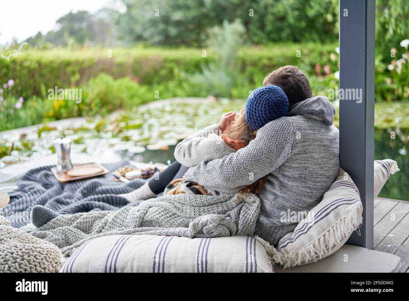 Affectionate couple cuddling on luxury patio Stock Photo - Alamy