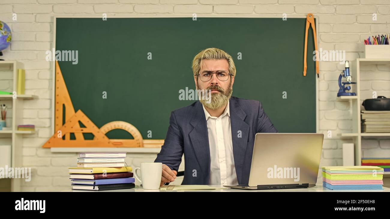 Selecting specific courses. School teacher programming laptop. Learn ...