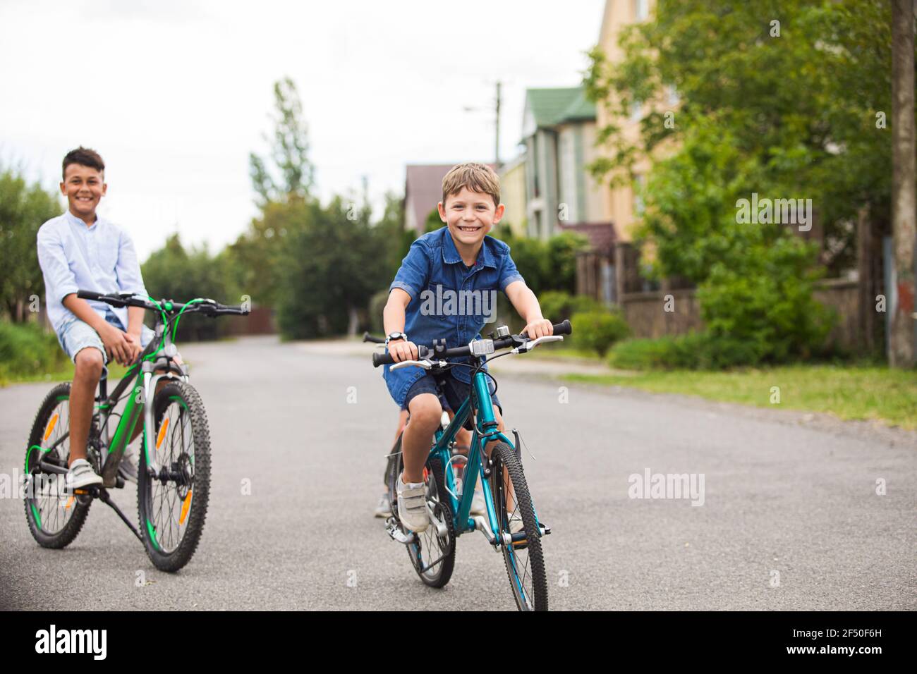 The friends on bicycles greet each other on the street Stock Photo - Alamy