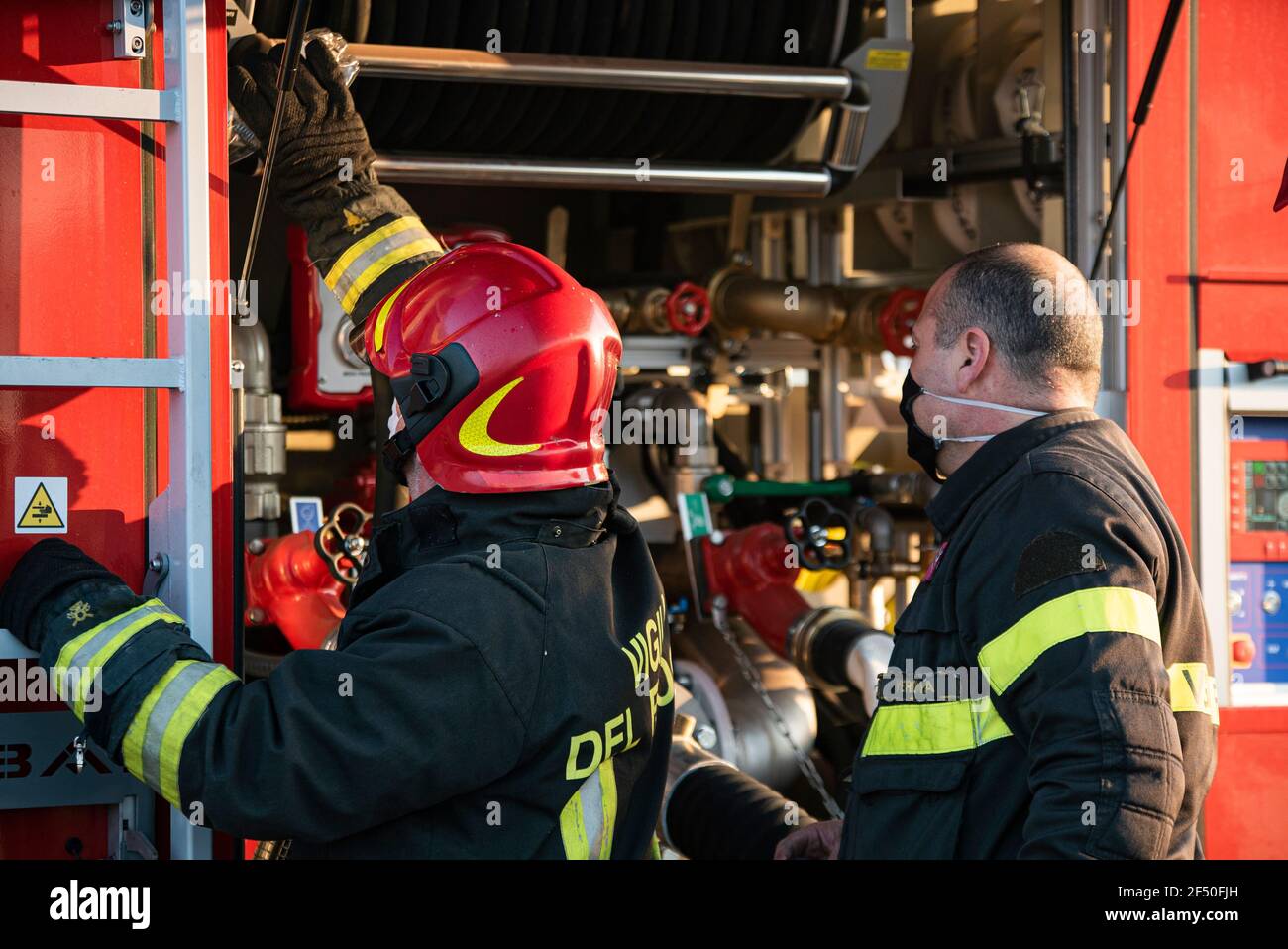 Firefighters pump water 2 Stock Photo - Alamy