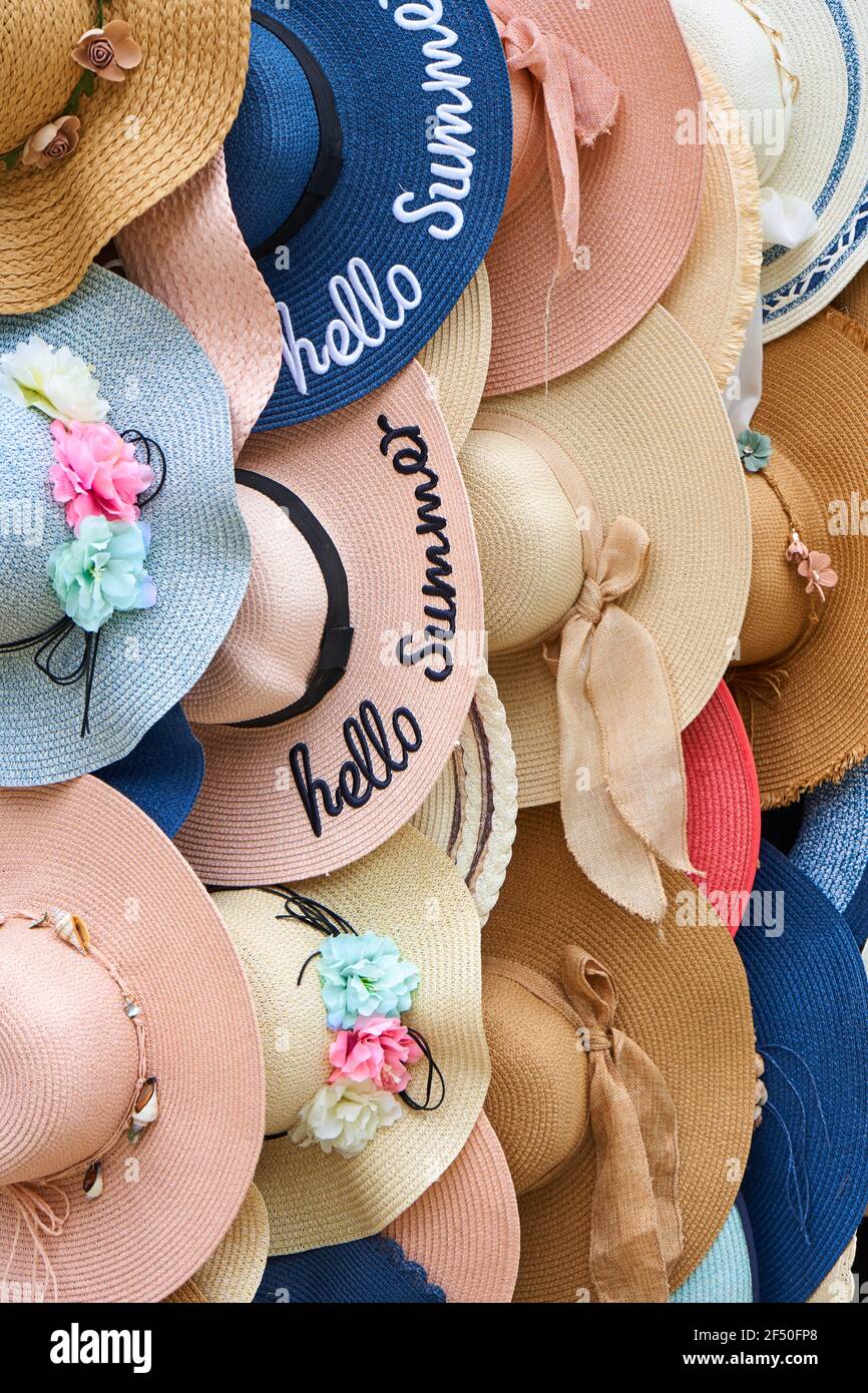 Shop with hats of various styles in the street market. Showcase with ...