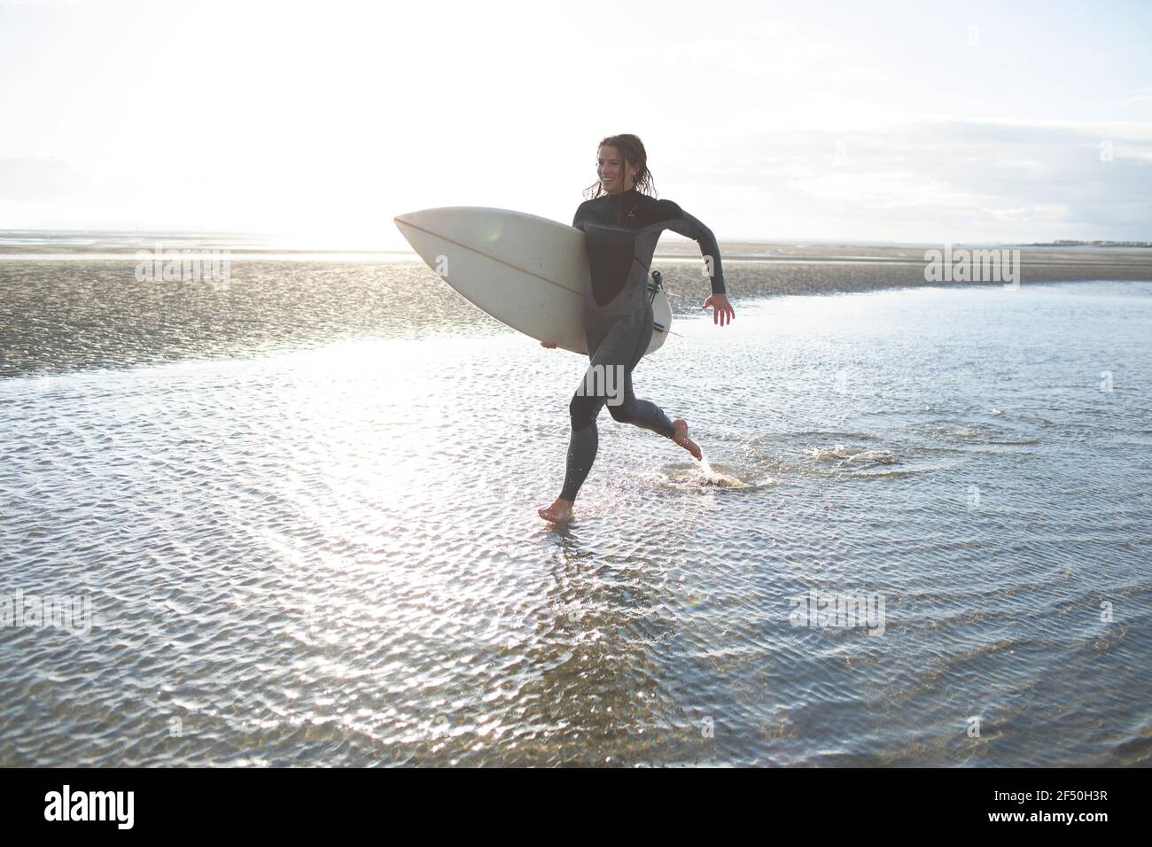 Female surfer surfboard in wetsuit hi-res stock photography and images ...