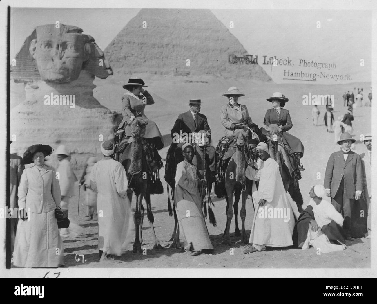 Giza (Egypt). Tourists and native leaders with camels in front of the ...
