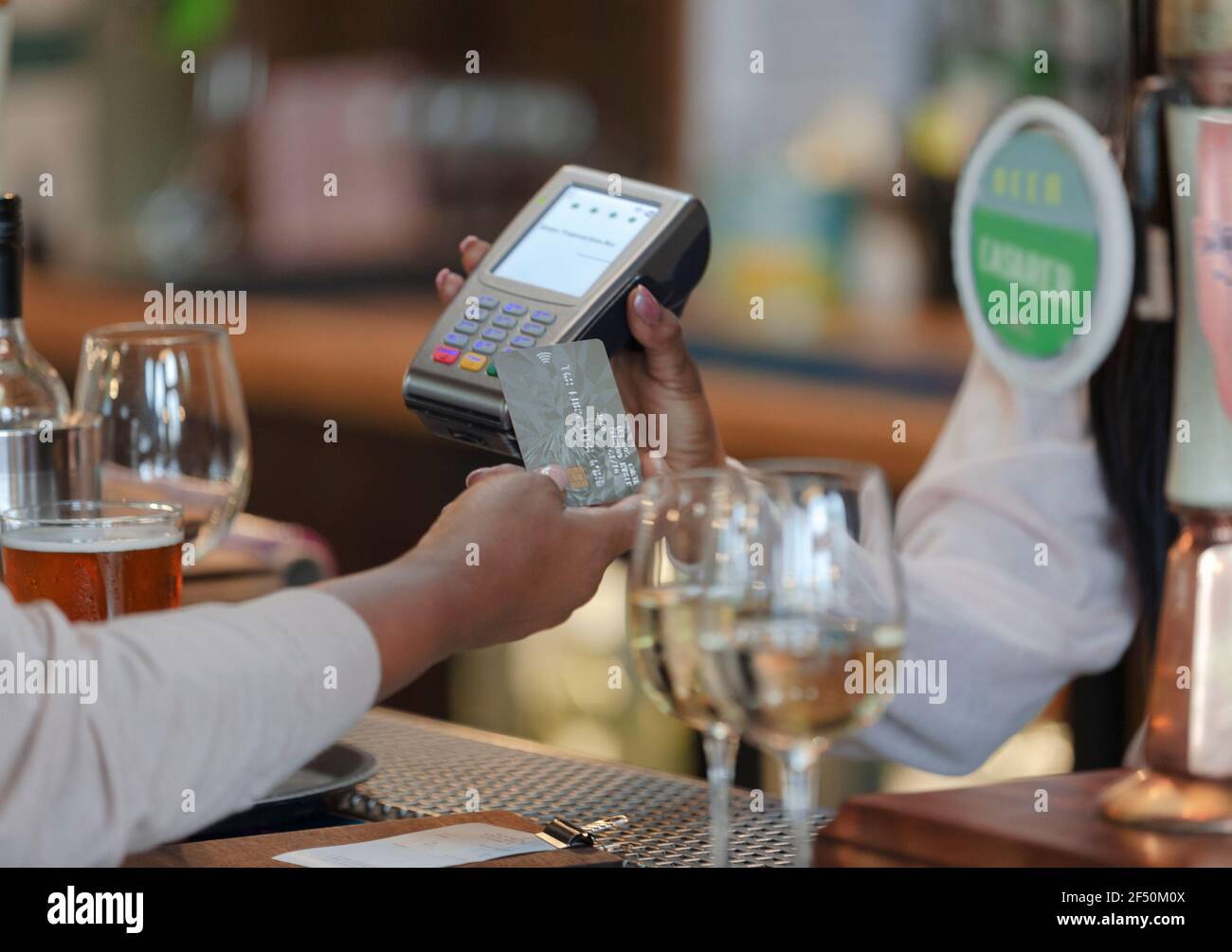 Close up customer paying bartender with smart card in bar Stock Photo ...