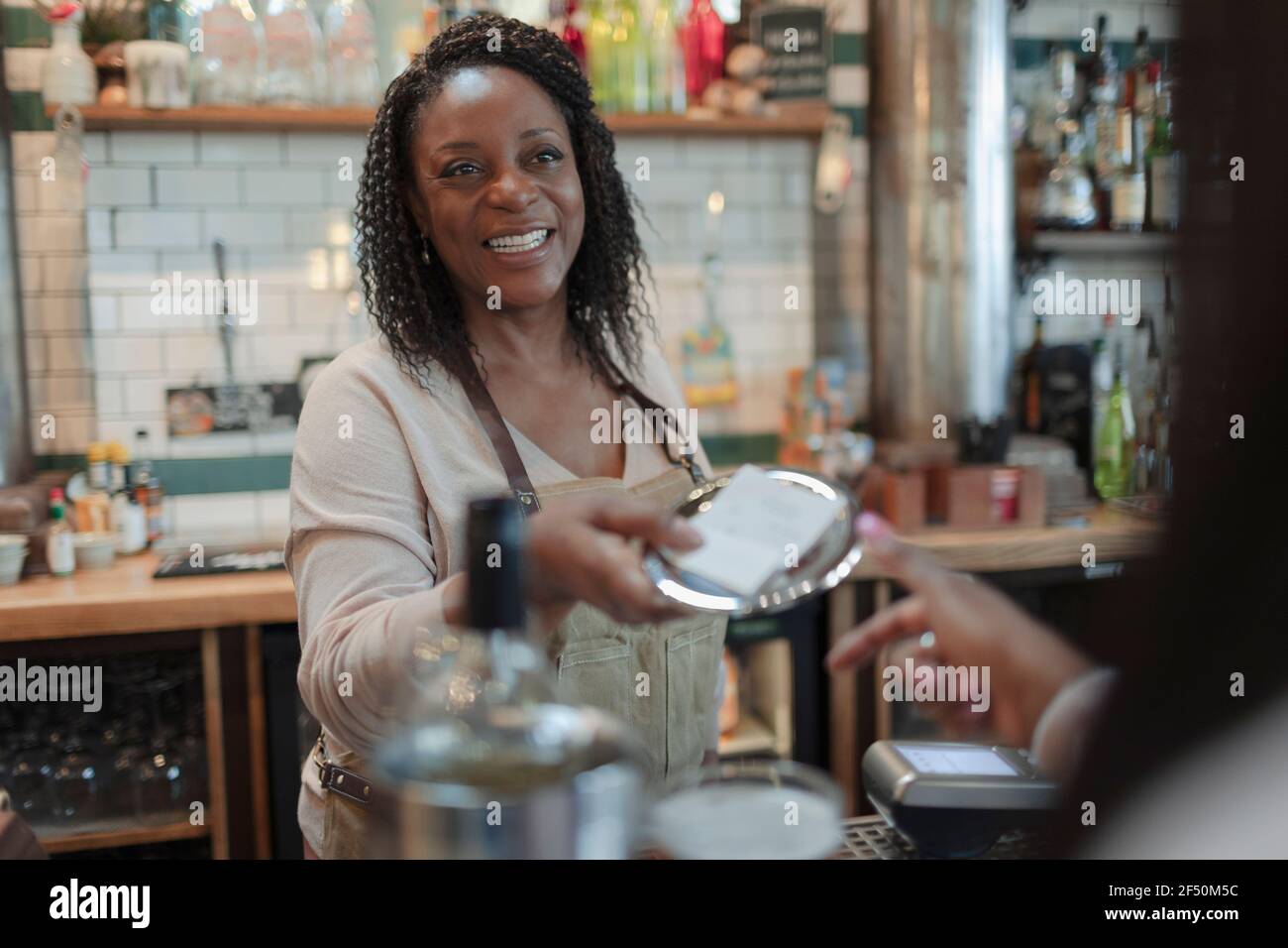 Giving receipt to customer hi-res stock photography and images - Alamy