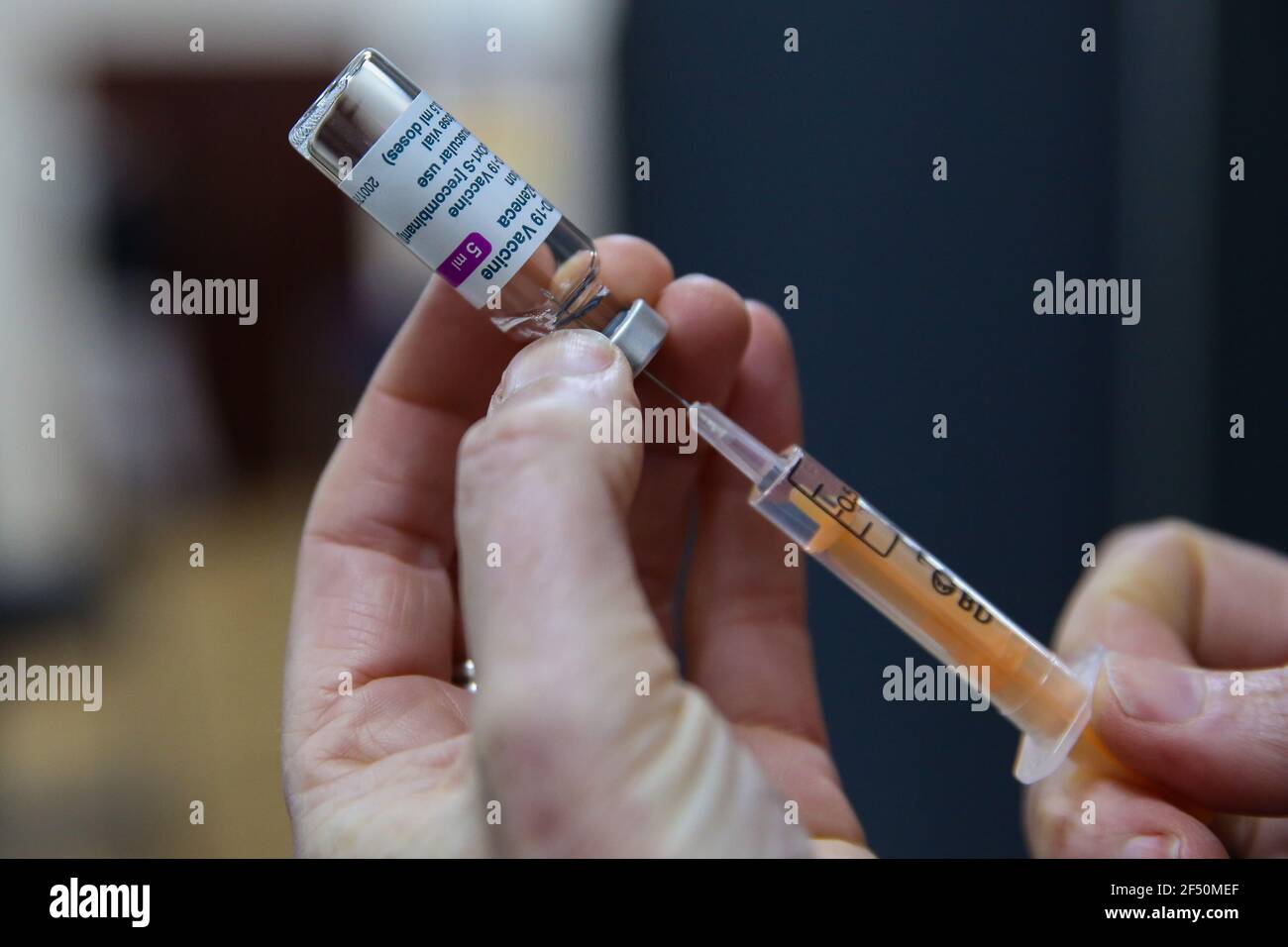 In this photo illustration, the NHS staff member holding the Oxford ...