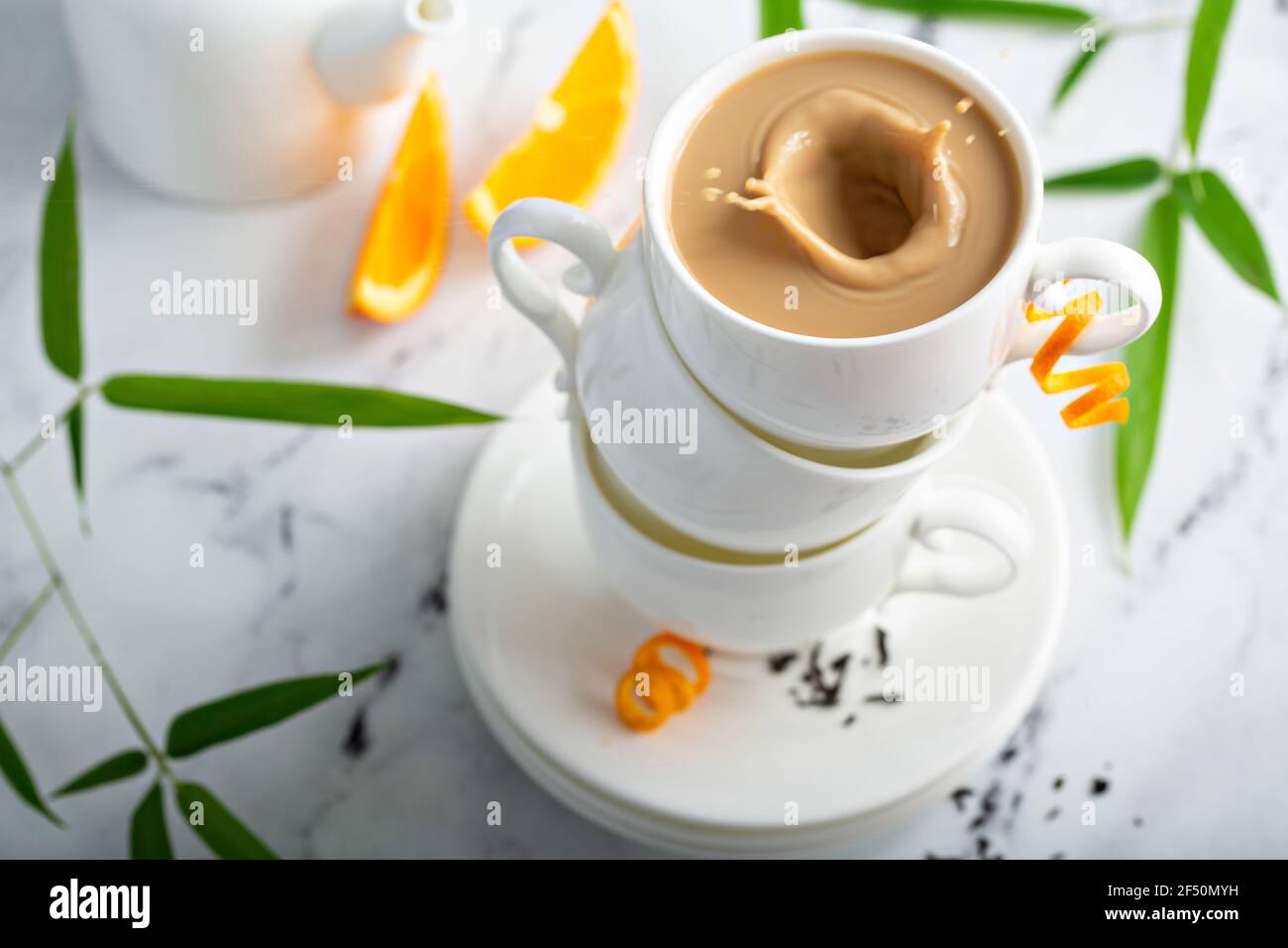 Earl grey milk tea poured in stacked cups Stock Photo - Alamy