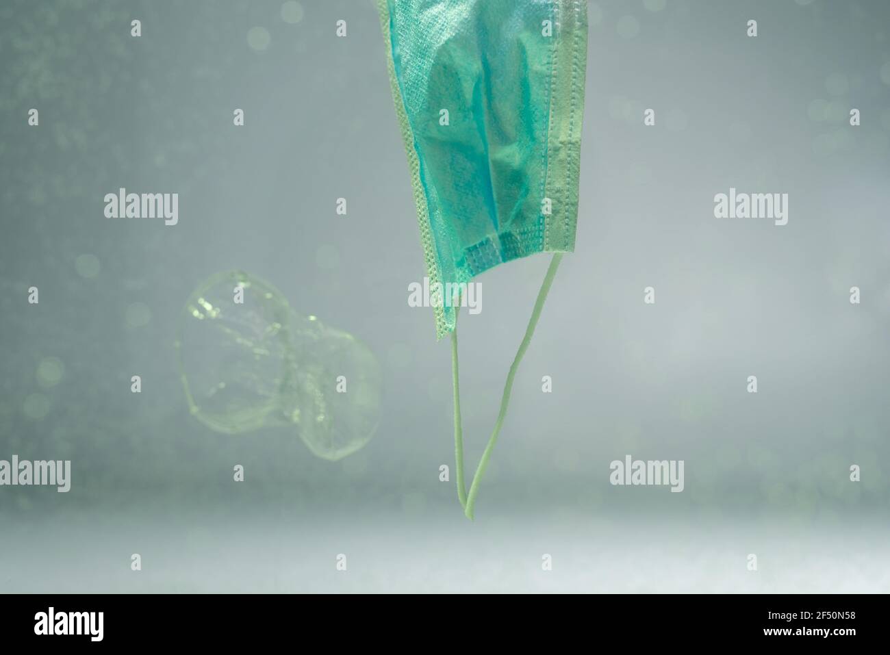 plastic cup and used medical mask in water, ecology concept Stock Photo ...