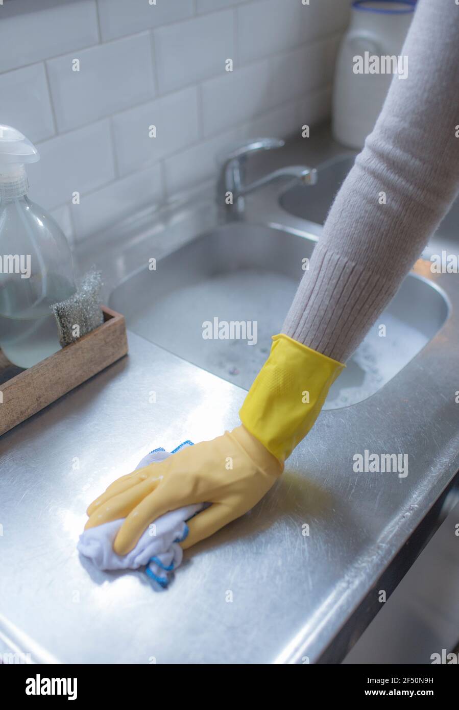 Woman in rubber glove cleaning kitchen counter Stock Photo - Alamy