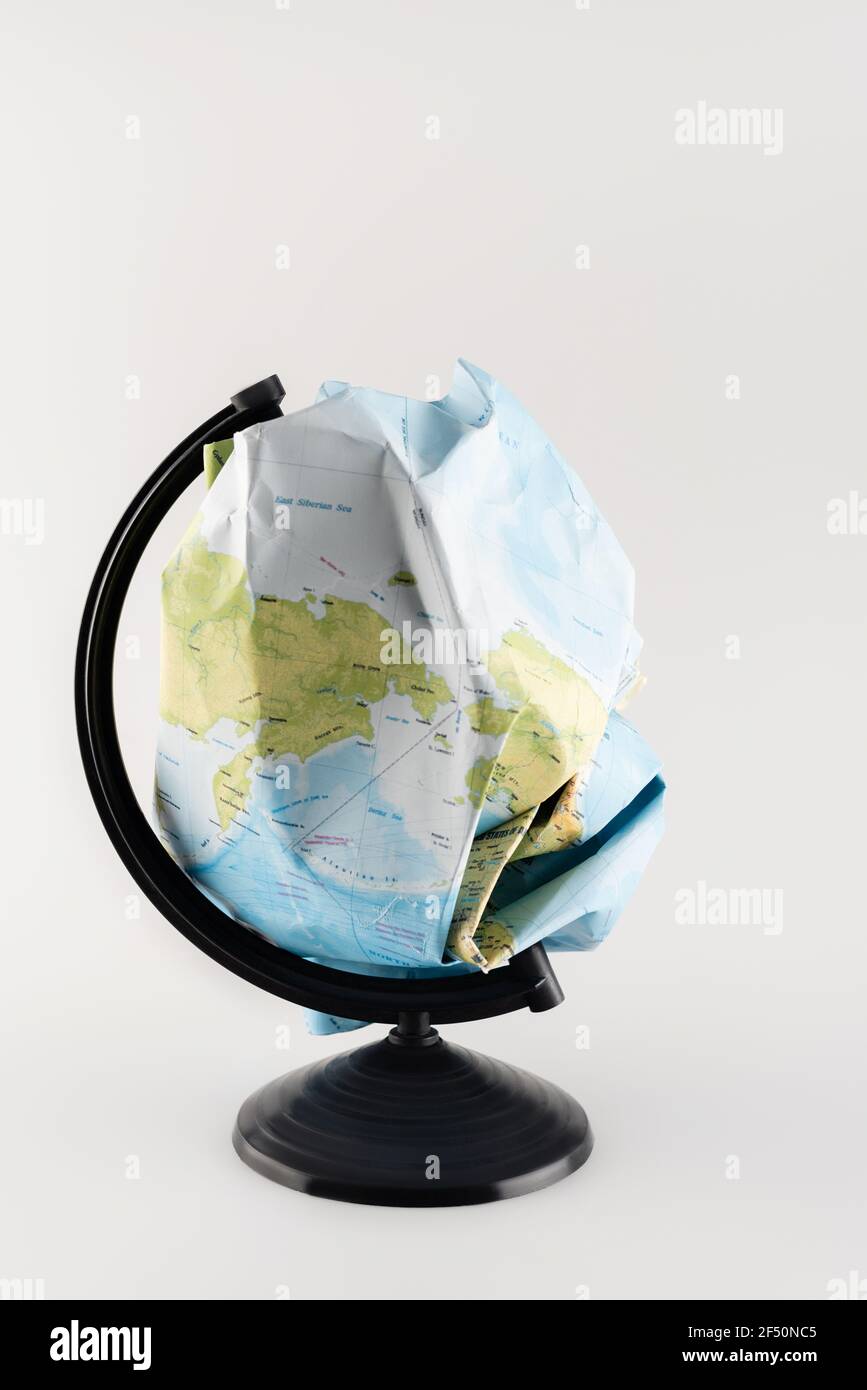 crumpled map instead of globe on stand isolated on grey, ecology ...