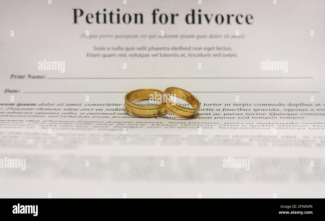 Conceptual image for divorce with two golden wedding rings in the ...