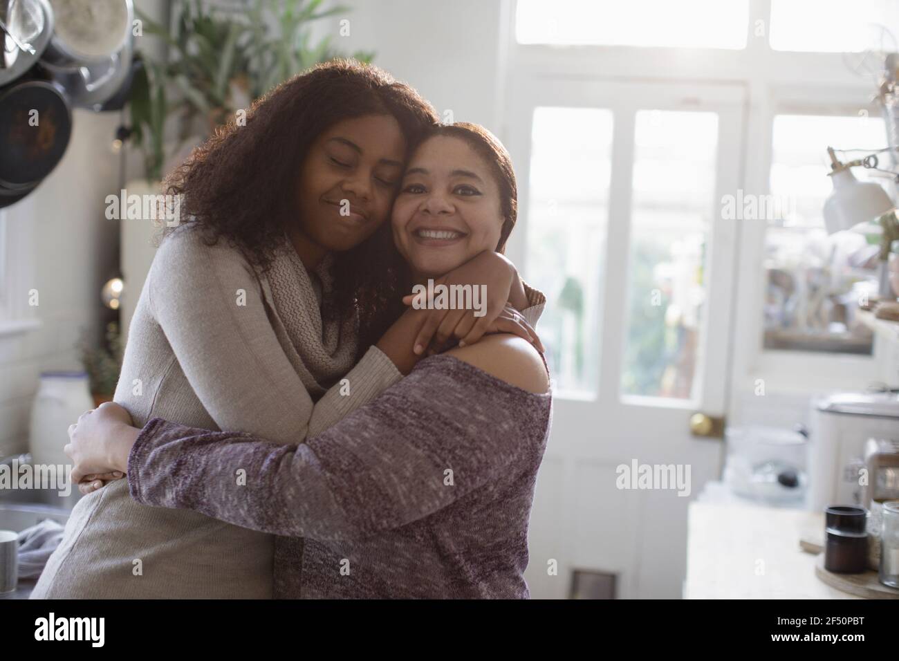 Portrait mother hugging daughter in hi-res stock photography and images - Alamy