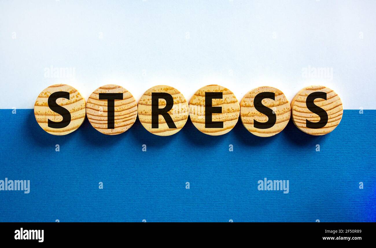 Stop stress and be health symbol. Wooden circles with the word 'stress ...