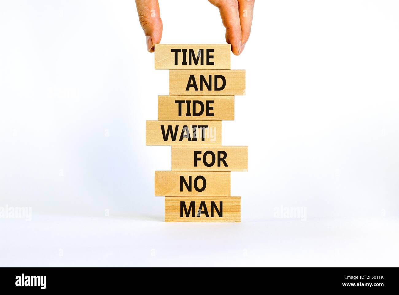 Time to action symbol. Wooden blocks with words time and tide wait for ...