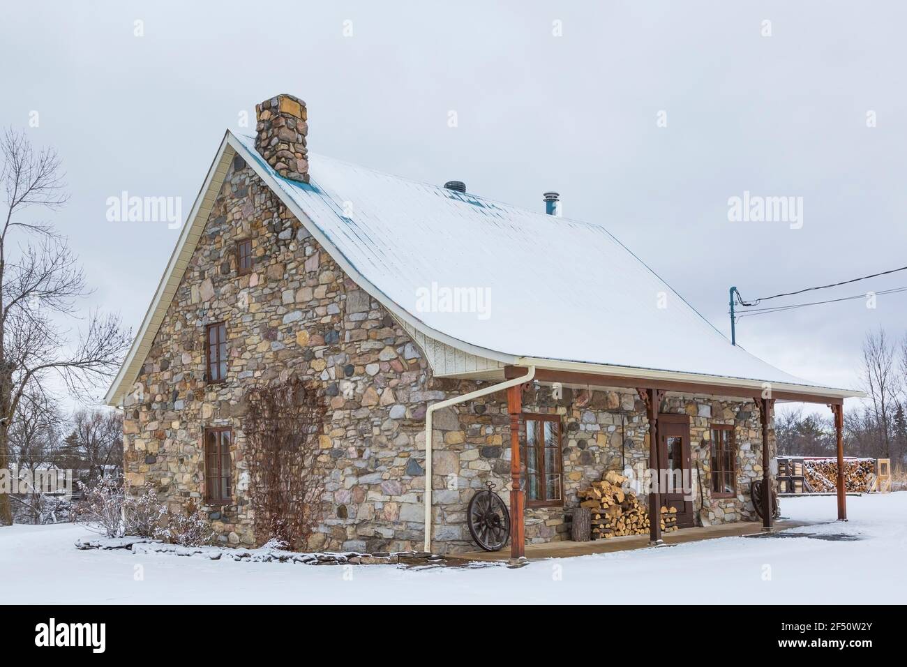 Old 1807 river and fieldstone cottage style house facade in winter ...
