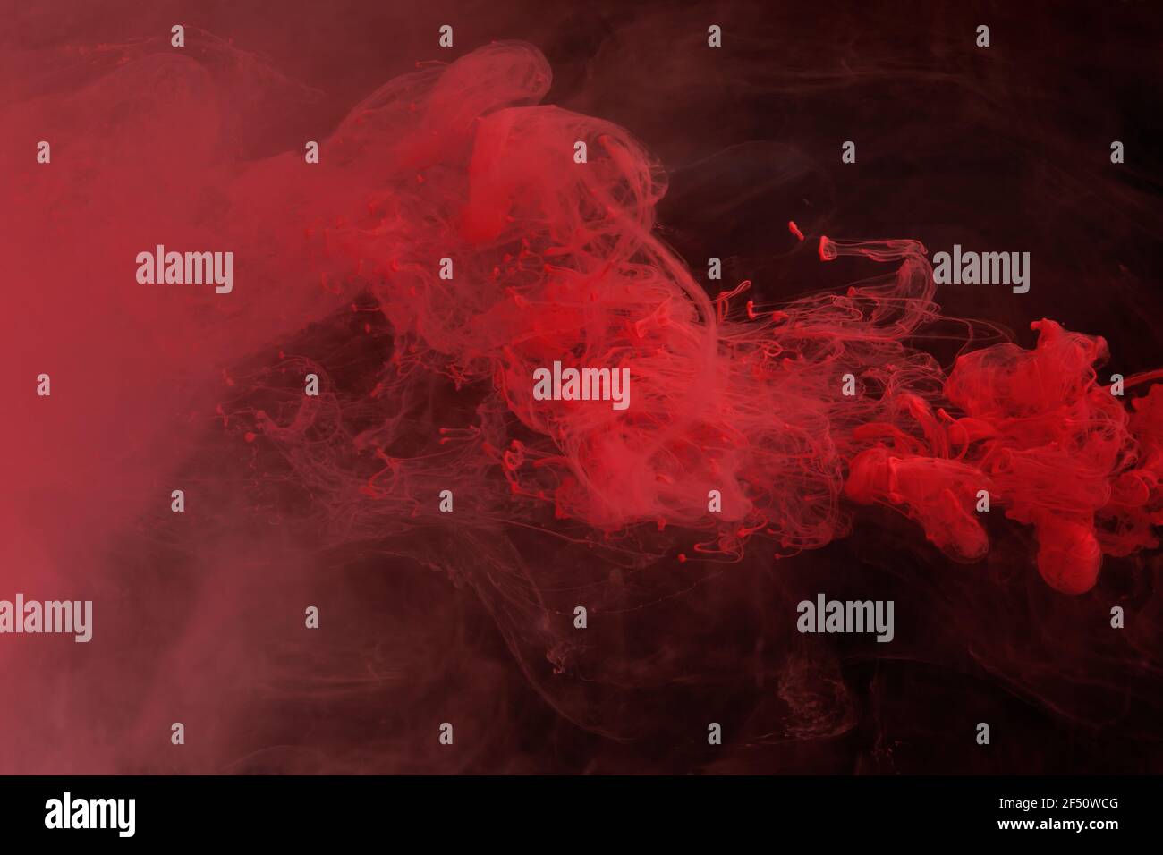 Abstract pattern background falling into the water drop of red paint ...