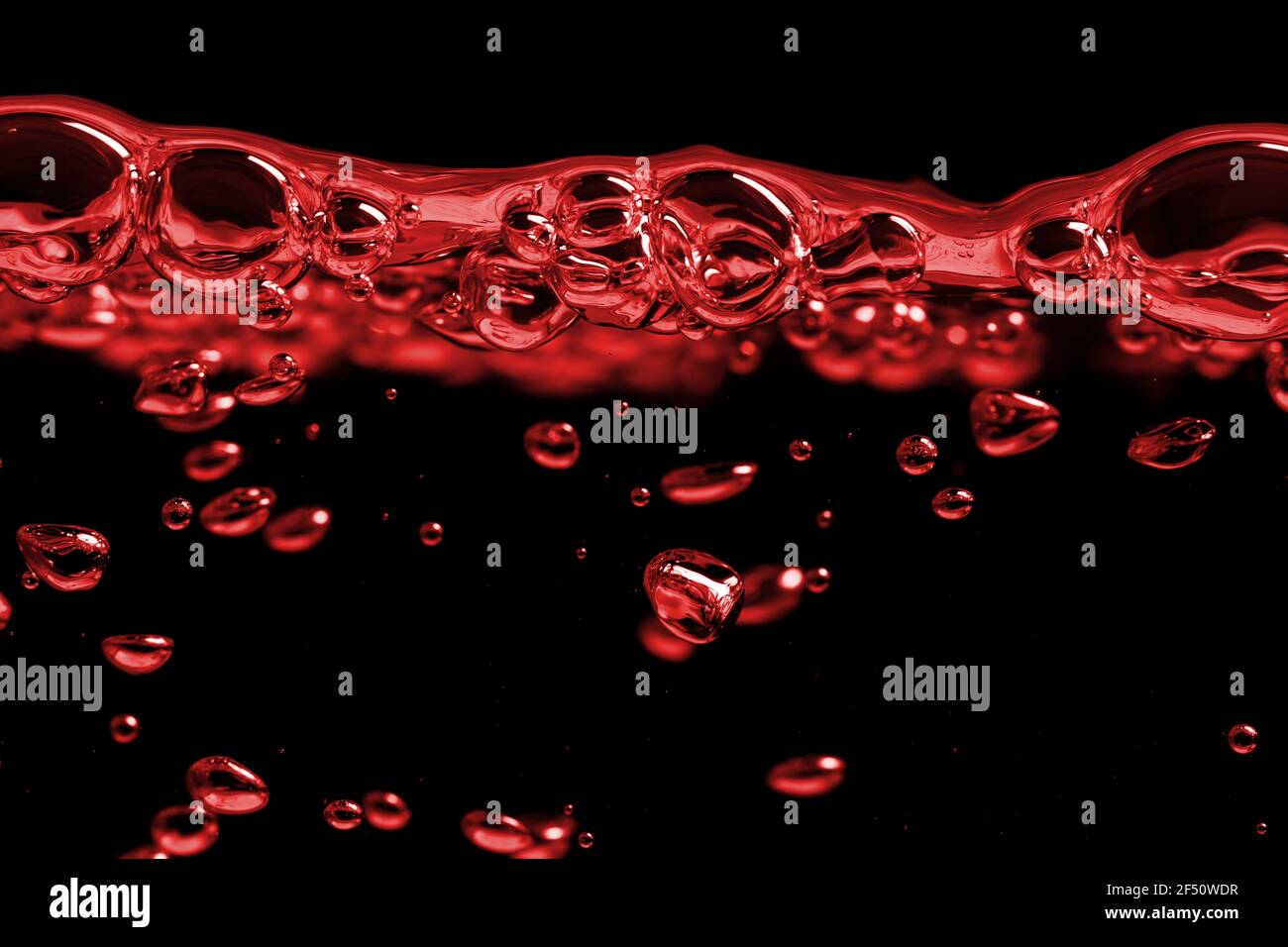 A red liquid surface. Clear splash surface of red wine or juice water ...
