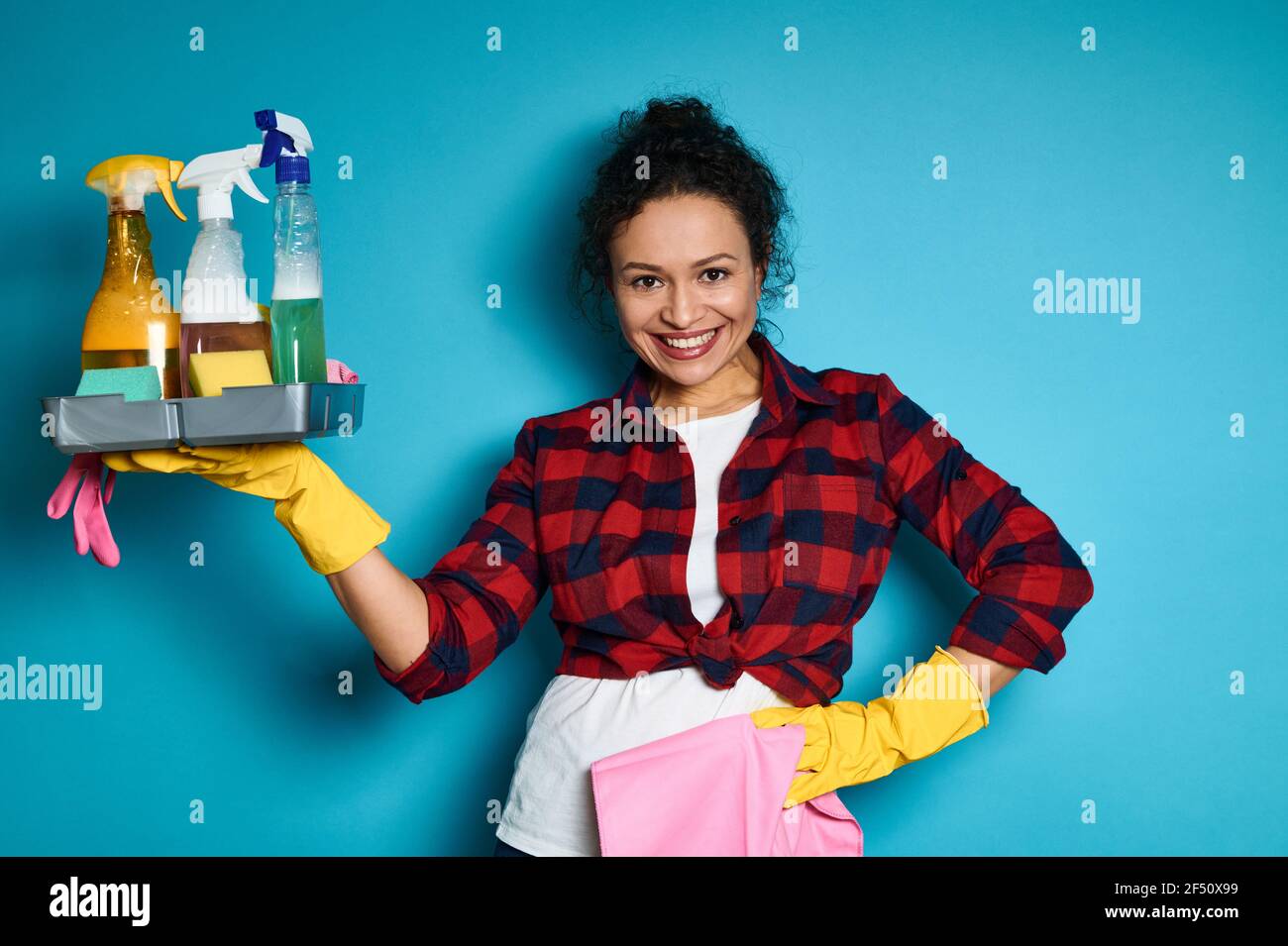 Smiling and happy Latin American woman raising her arm up with tray ...
