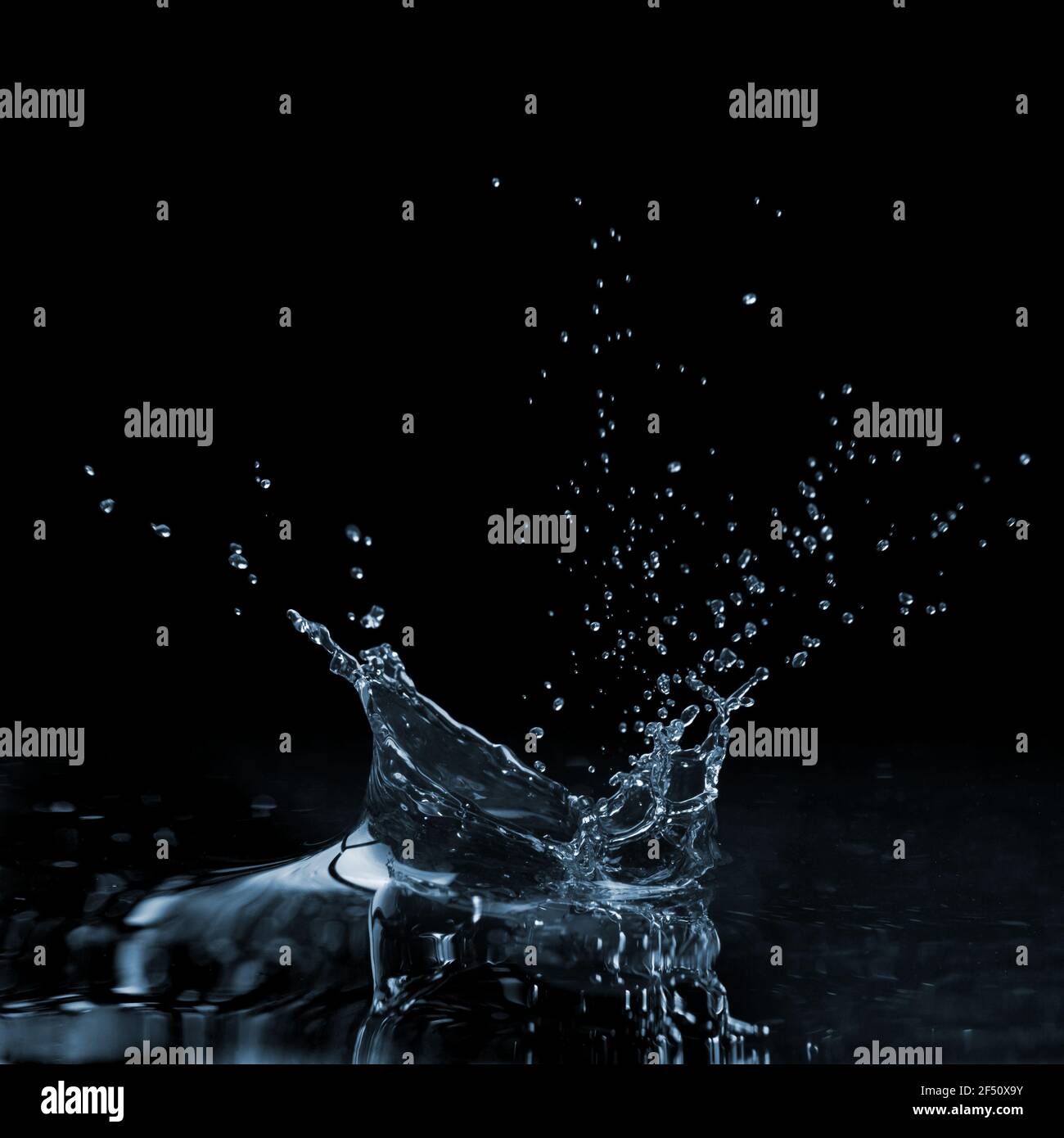 Clear, beautiful splash with drops on the water surface Stock Photo - Alamy