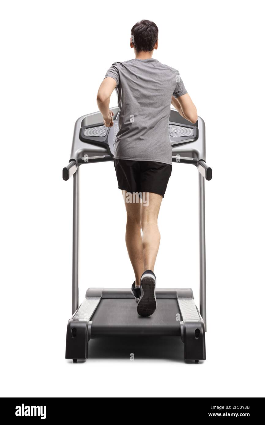 Rear view shot of a slim man running on a treadmill isolated on white ...