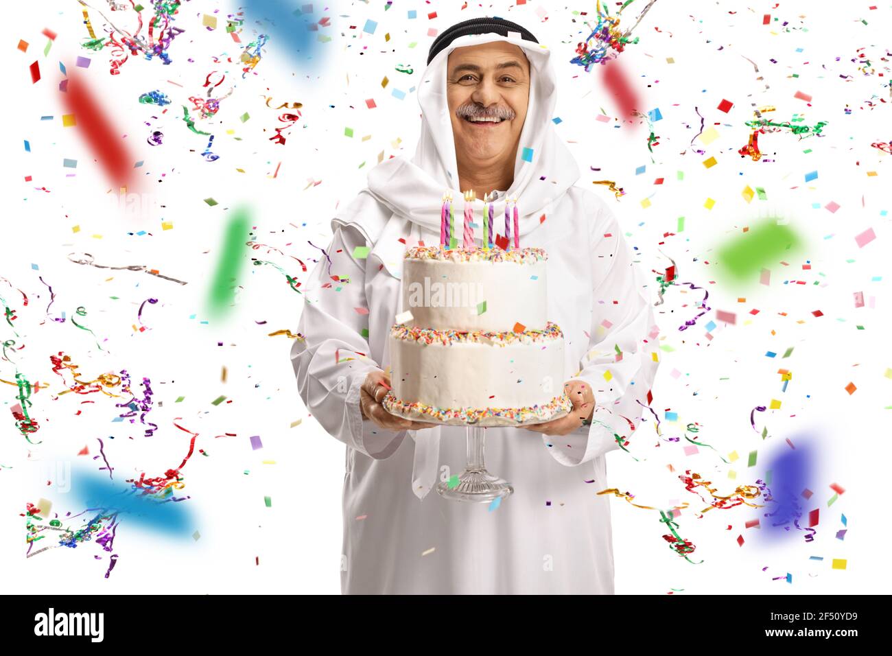 Mature arab man holding a birthday cake with confetti around isolated ...