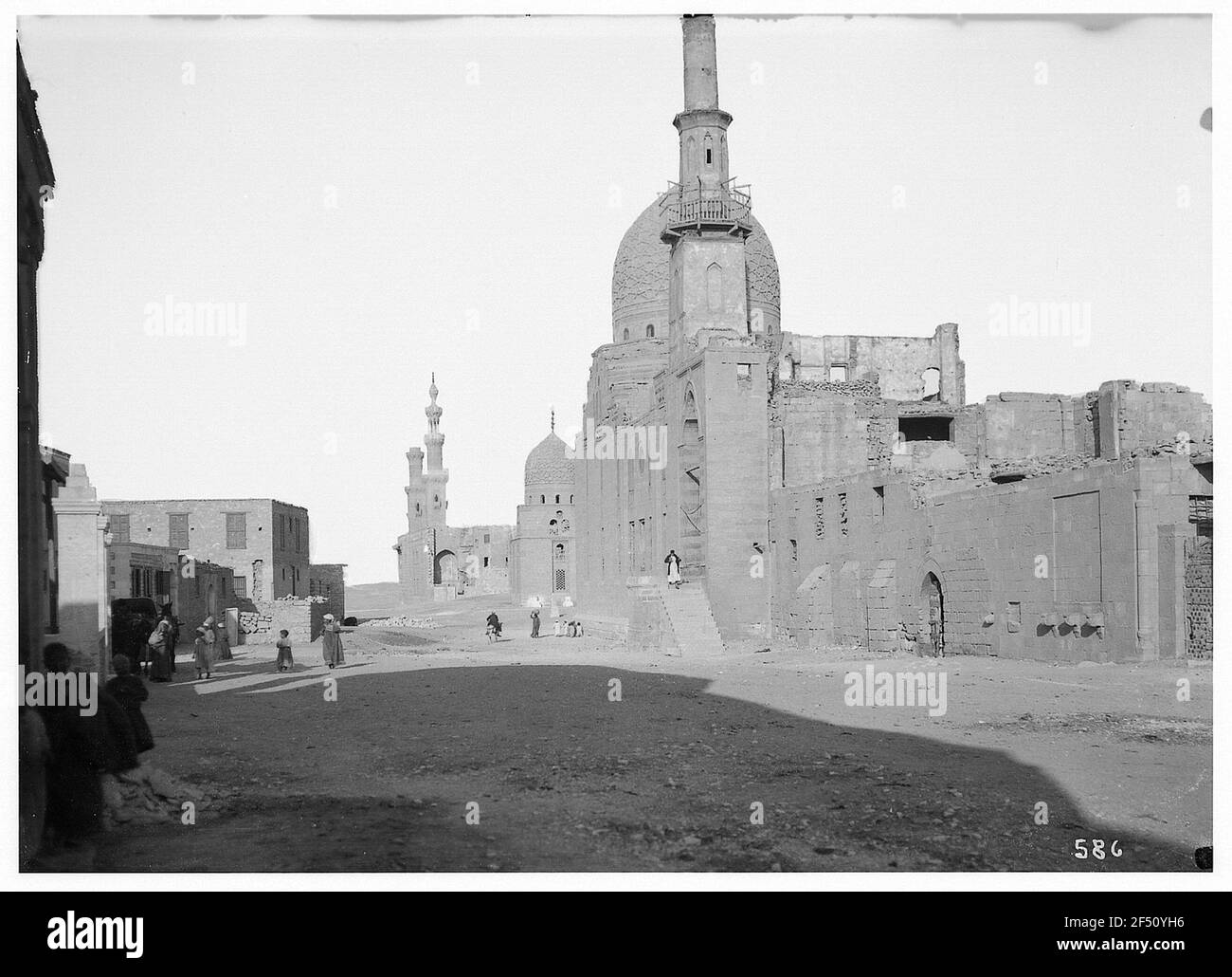 Cairo (Egypt). Street scene with locals in front of the ruin of a ...