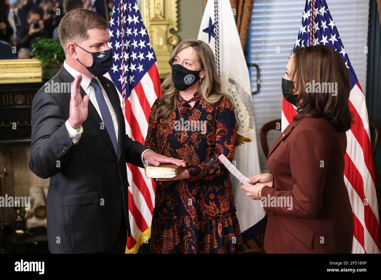 Vice President Kamala Harris, right swears-in, Marty Walsh left, as the ...