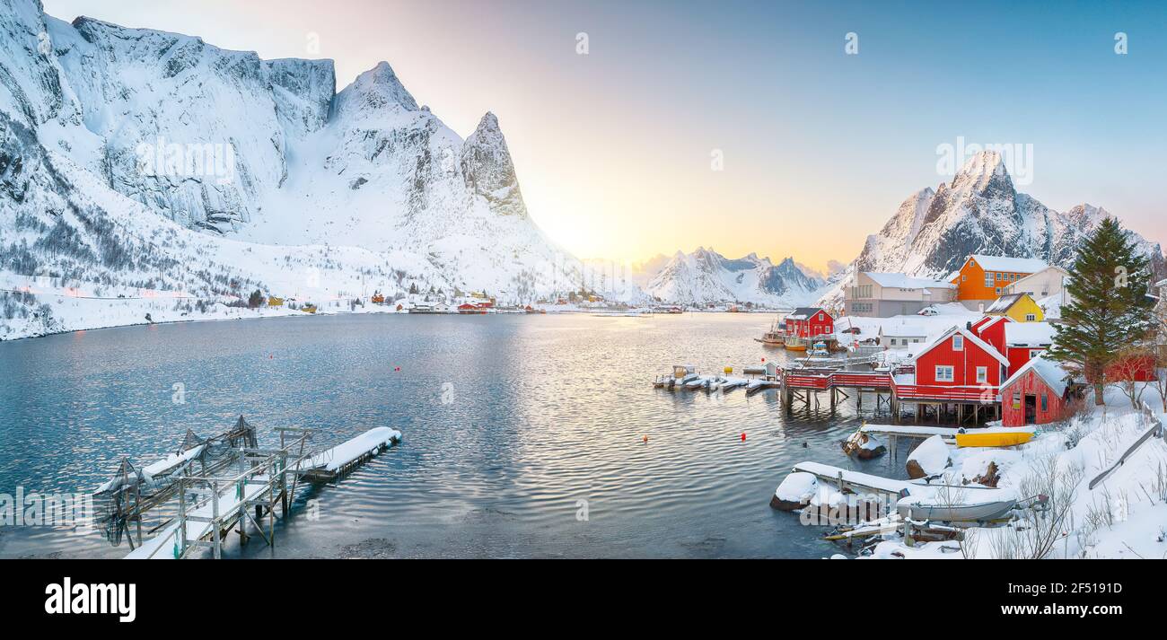 Fantastic evening panorama of Reine town. Red rorbuers on the shore of ...