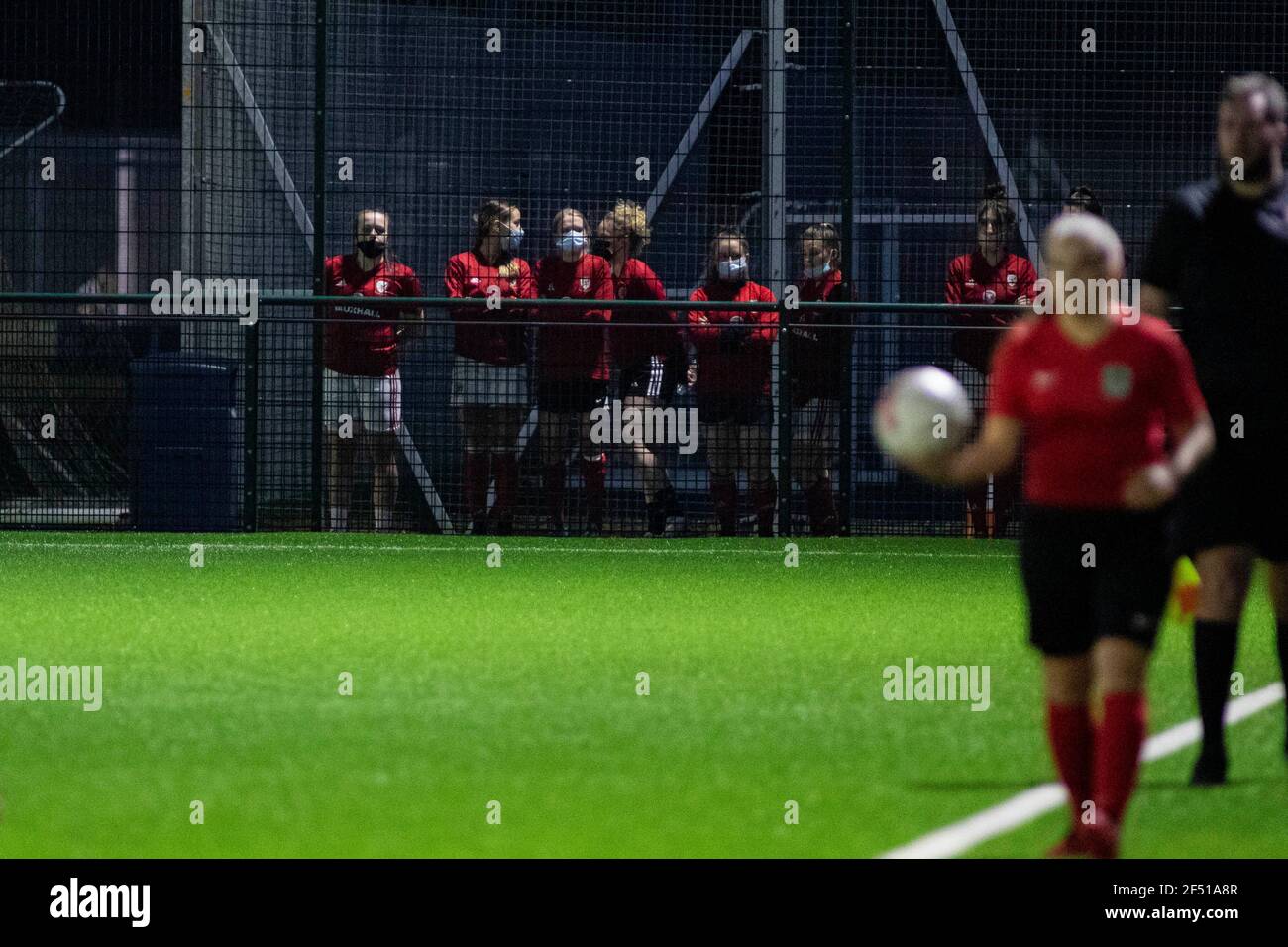 Members of the Welsh Girls squad watch the match from outside the ...