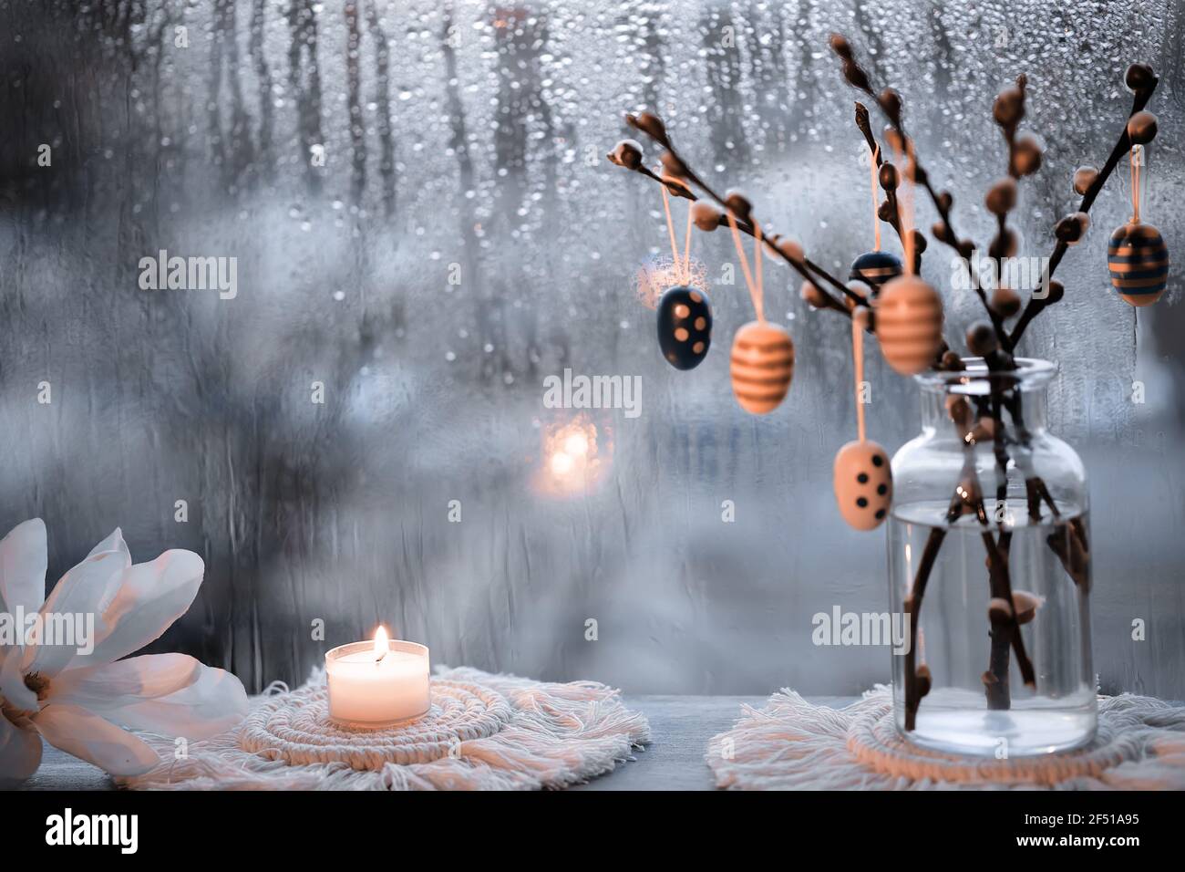 Evening window in Spring, wooden Easter eggs on pussy willow twigs in ...