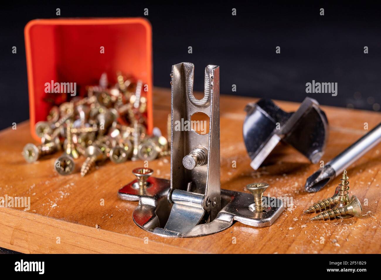 Installation of metal hinges to the chipboard. Carpentry work when ...