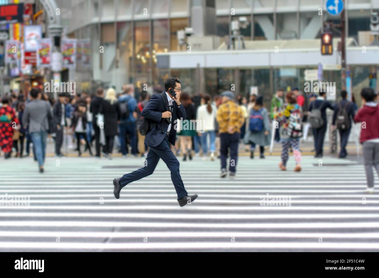 Man running at Shibuya crossing Stock Photo - Alamy
