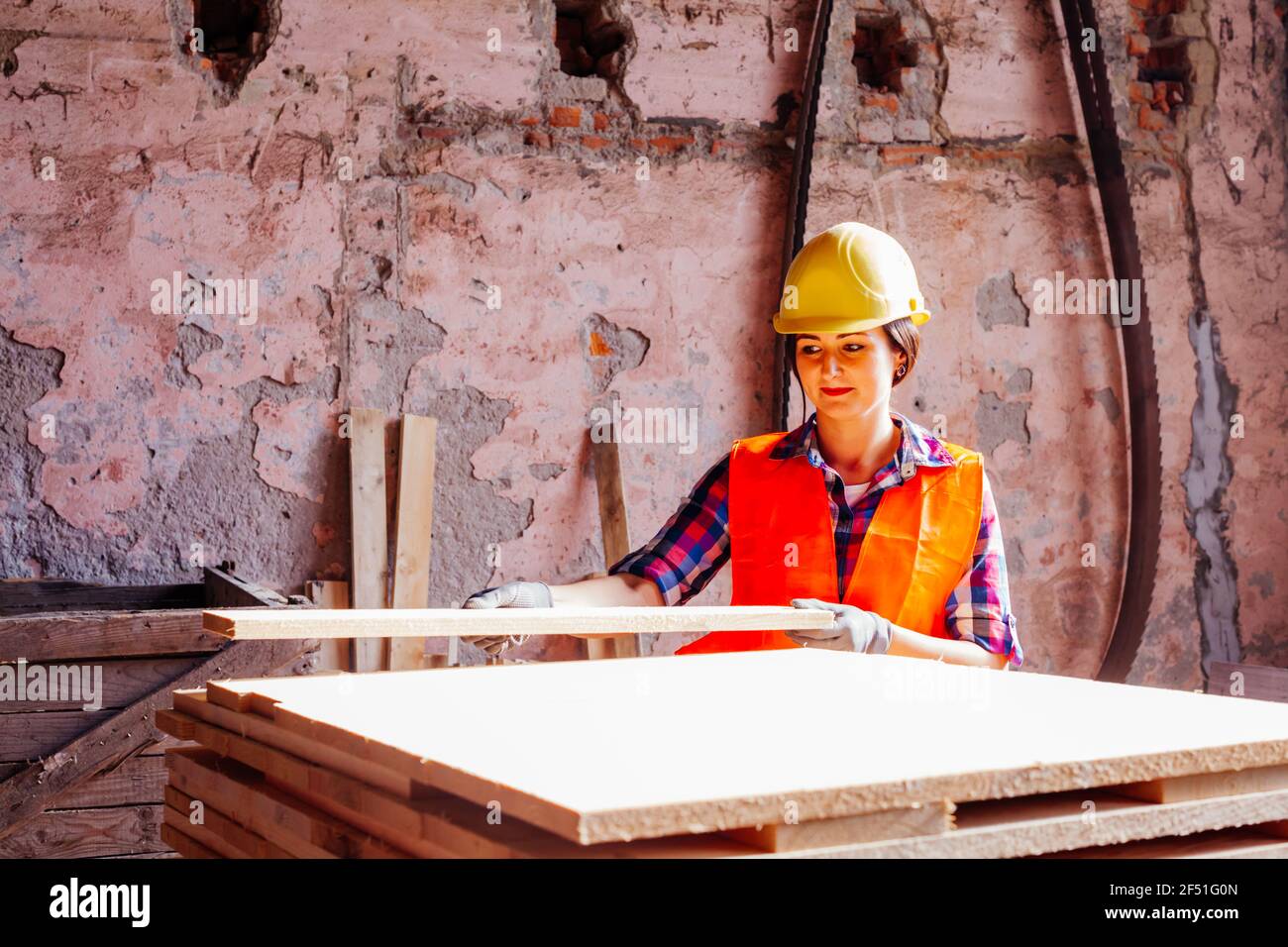 Woman worker at the plant, wearing yellow hard Stock Photo - Alamy