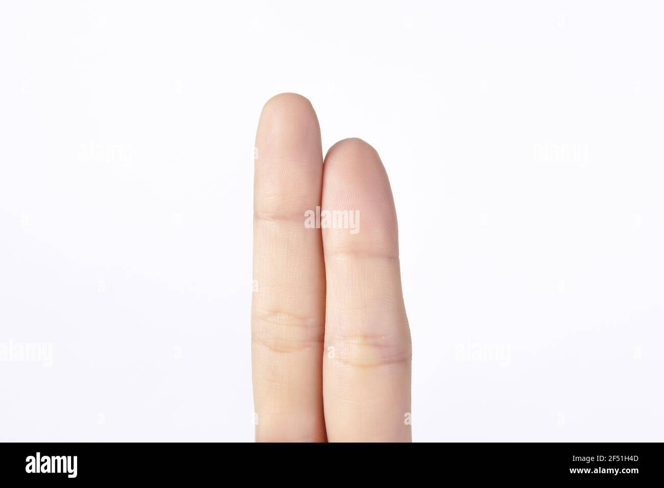 Closeup of the middle and index finger of a person isolated on a white ...
