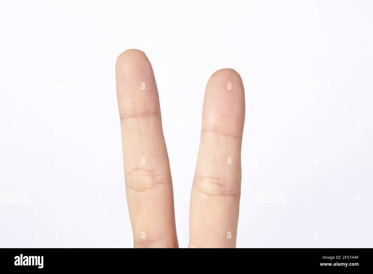 Closeup of a person doing the peace sign isolated on a white background ...