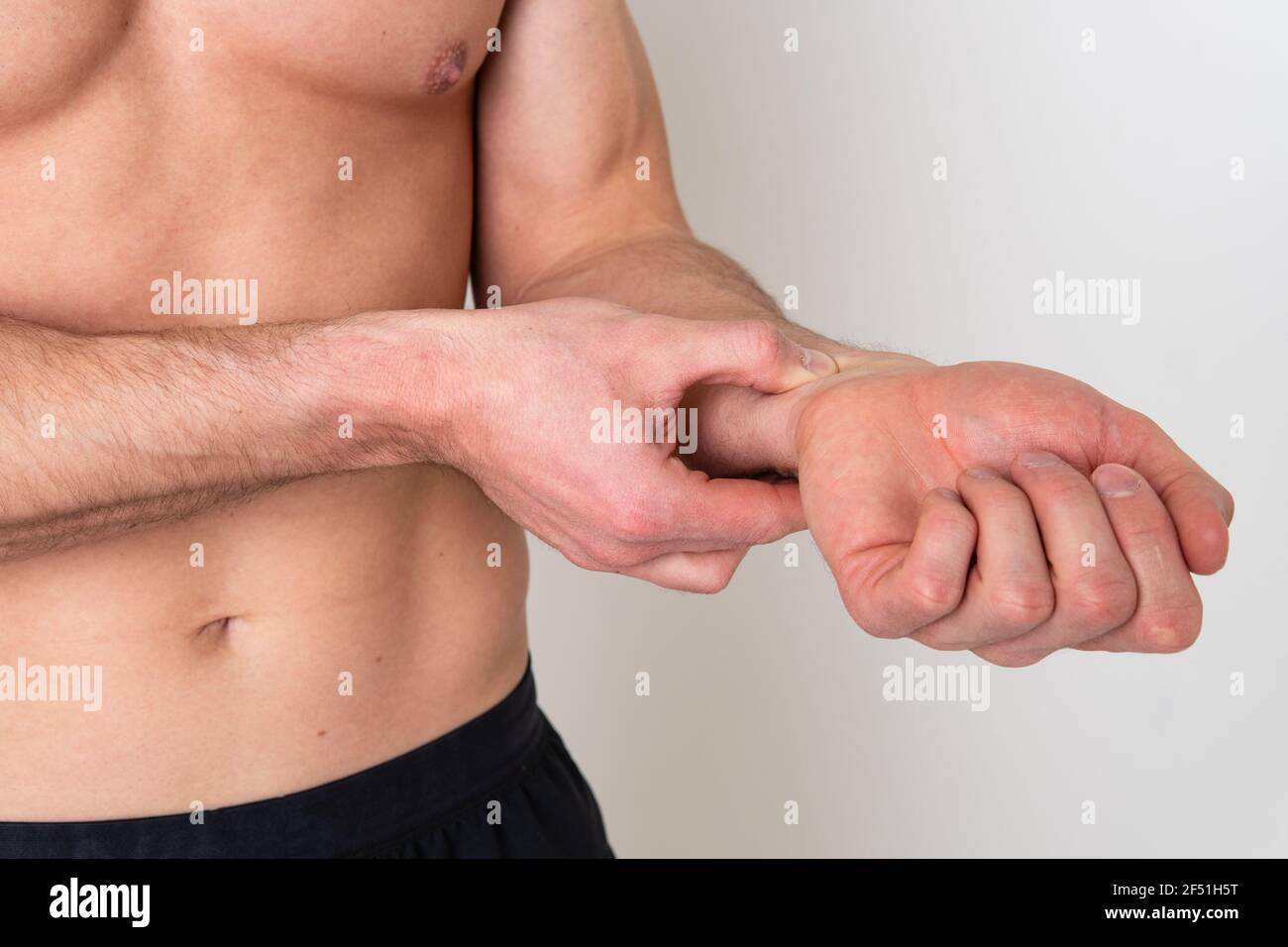 Measures Pulse on the hand of a white man in the background muscle ...
