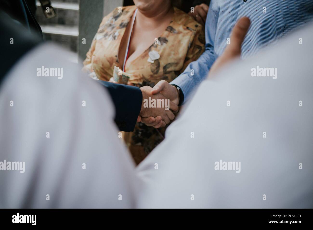 Closeup shot of a handshake during a wedding ceremony as a sign of a ...