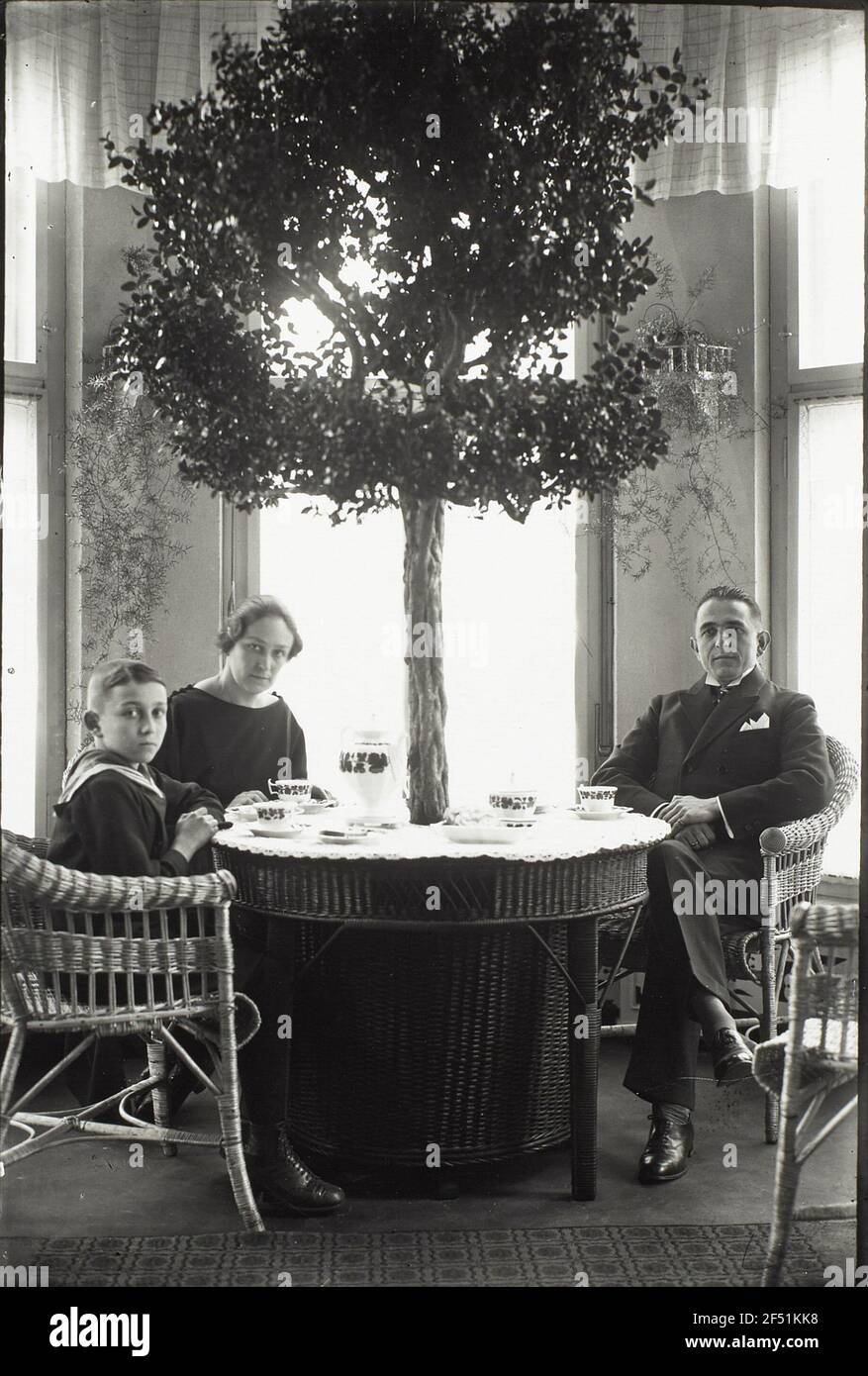 The shoe maker Carl fox with woman and son on the coffee table in his ...