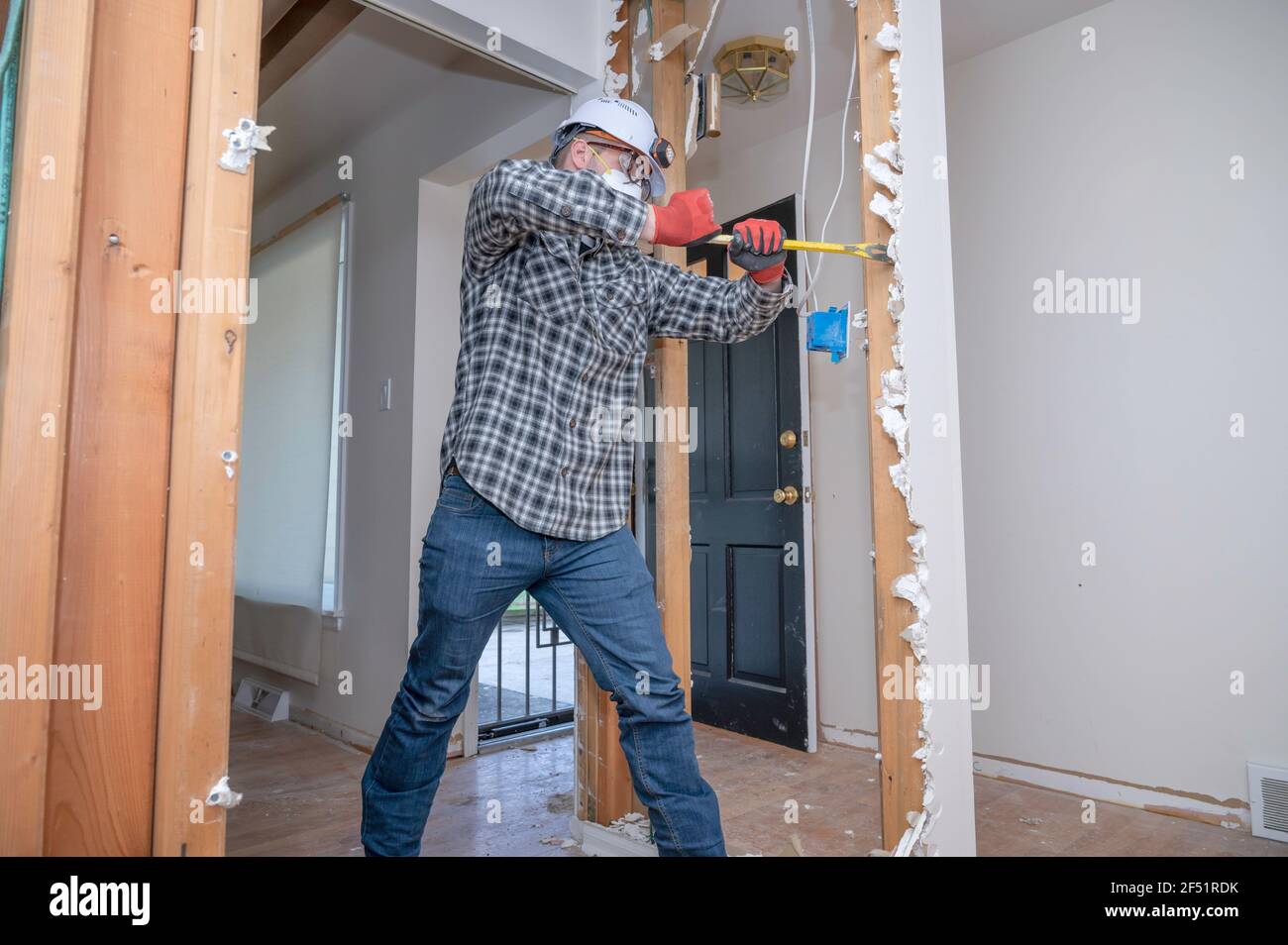 Contractor removing drywall panels during home remodeling project Stock ...