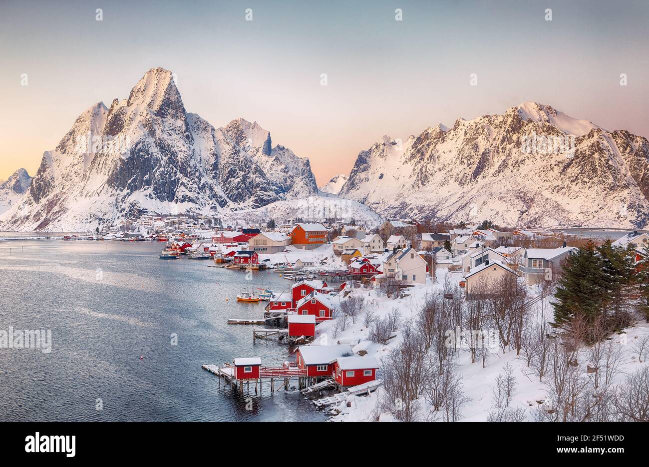 Fantastic evening panorama of Reine town. Red rorbuers on the shore of ...