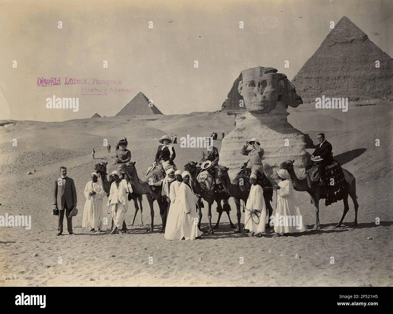 Giza, Egypt. Tourists on camels posing with native leaders in front of ...